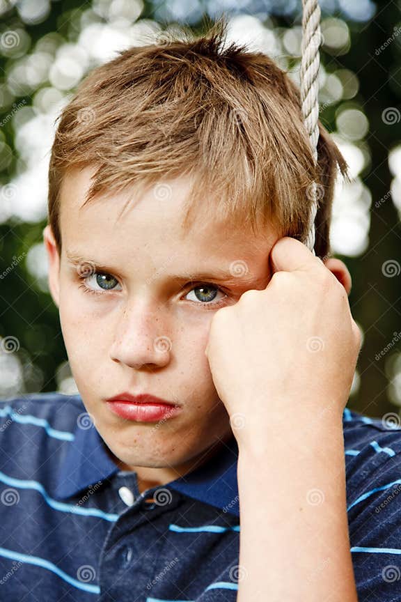 Sad Looking Boy Sitting on a Swing Stock Photo - Image of pensive ...