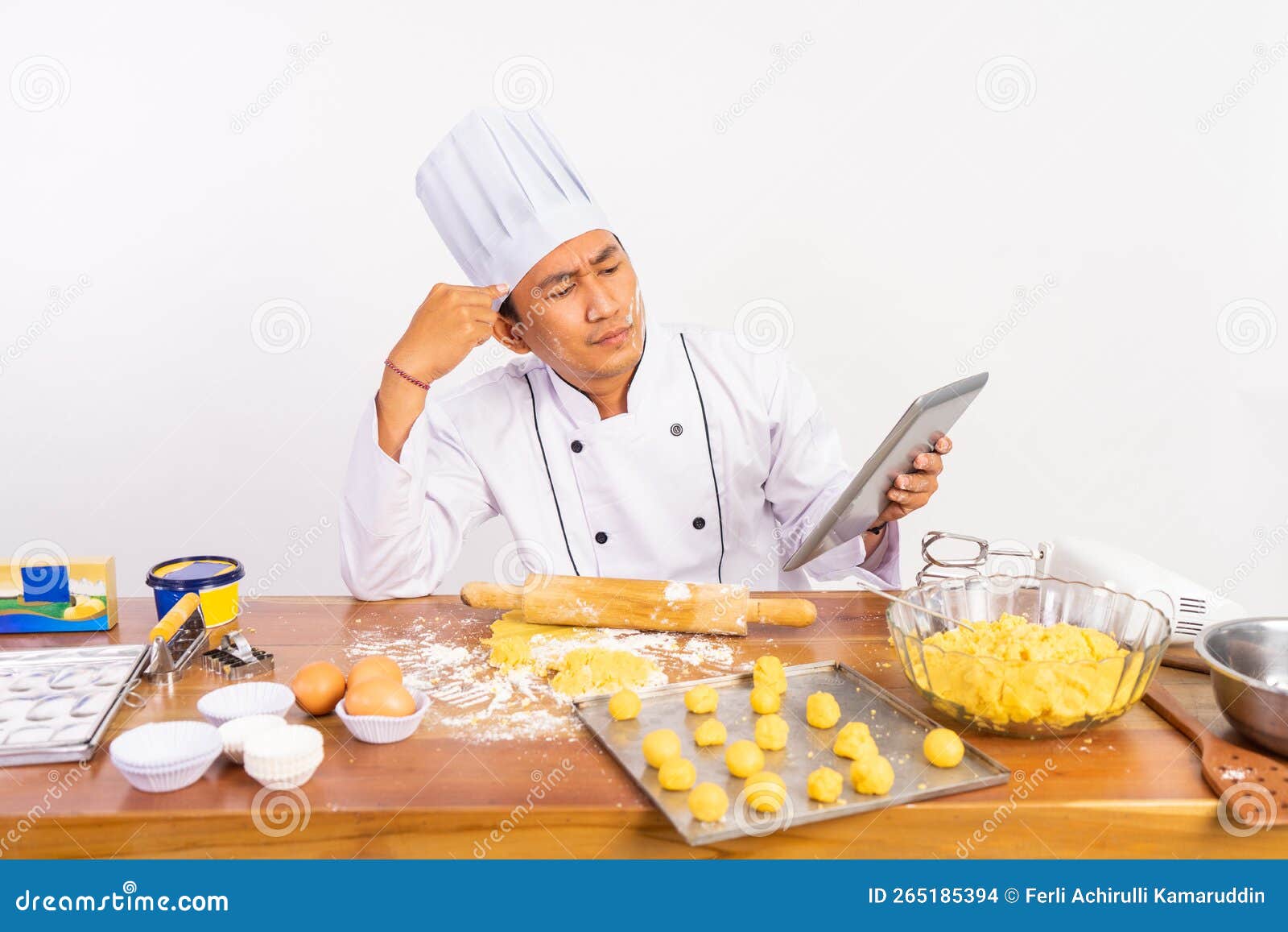 Sad Male Chef Using a Pad while Baking Cake Stock Photo - Image of ...