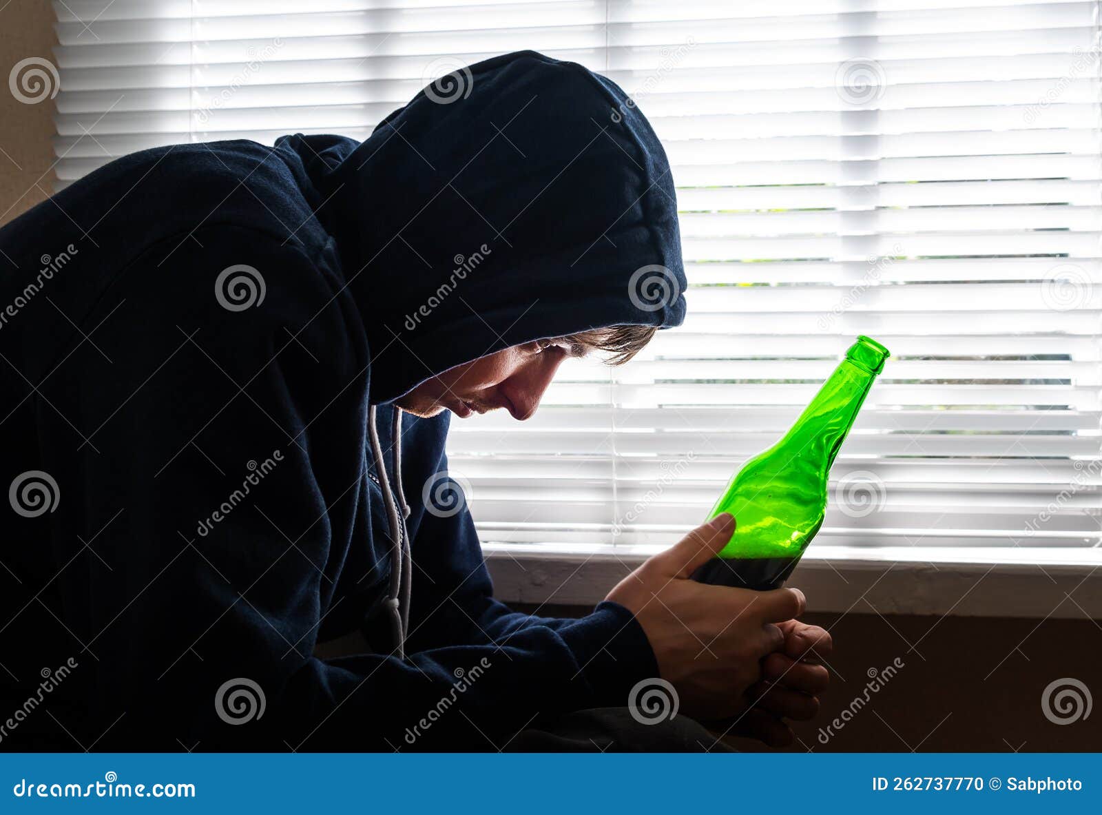 Sad Man with a Beer stock photo. Image of jalousie, room - 262737770