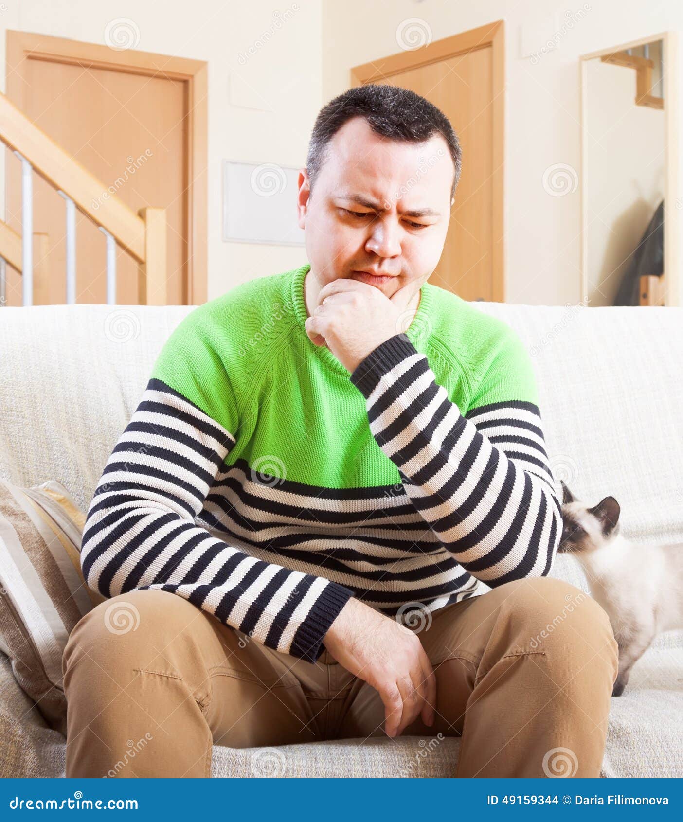 Sad man on couch stock photo. Image of melancholy, person - 49159344