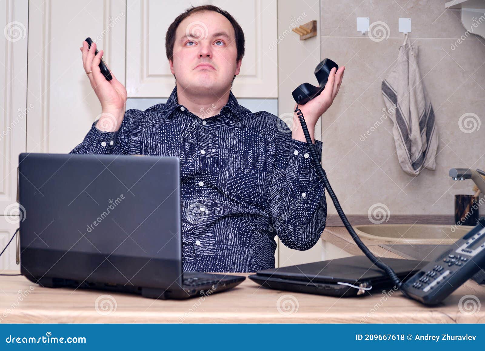 A Sad Man in Depression Sits in the Kitchen at a Laptop in a Home ...