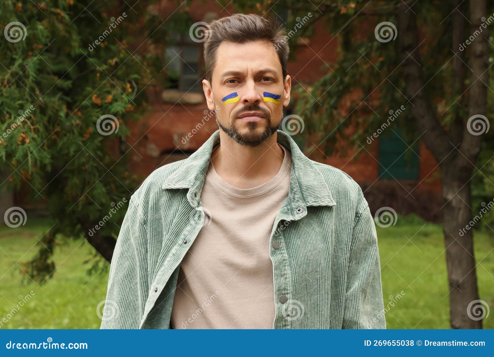Sad Man with Drawings of Ukrainian Flag on Face Outdoors Stock Photo ...
