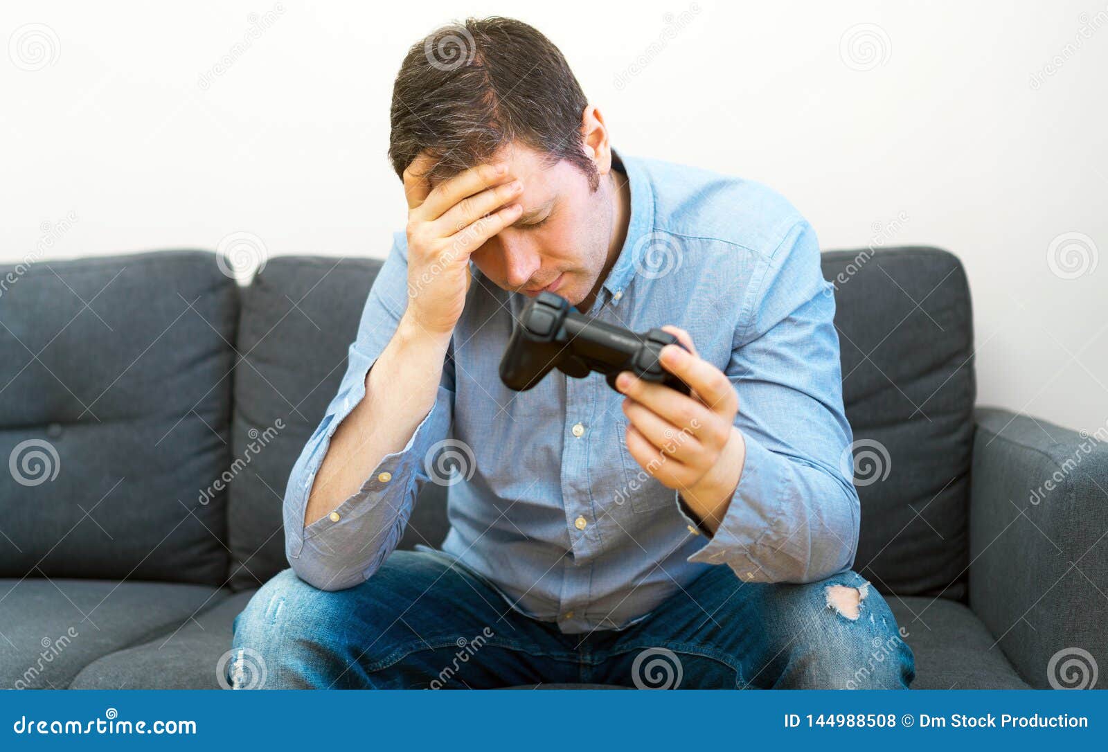 Sad man with gamepad stock photo. Image of failure, defeat - 144988508