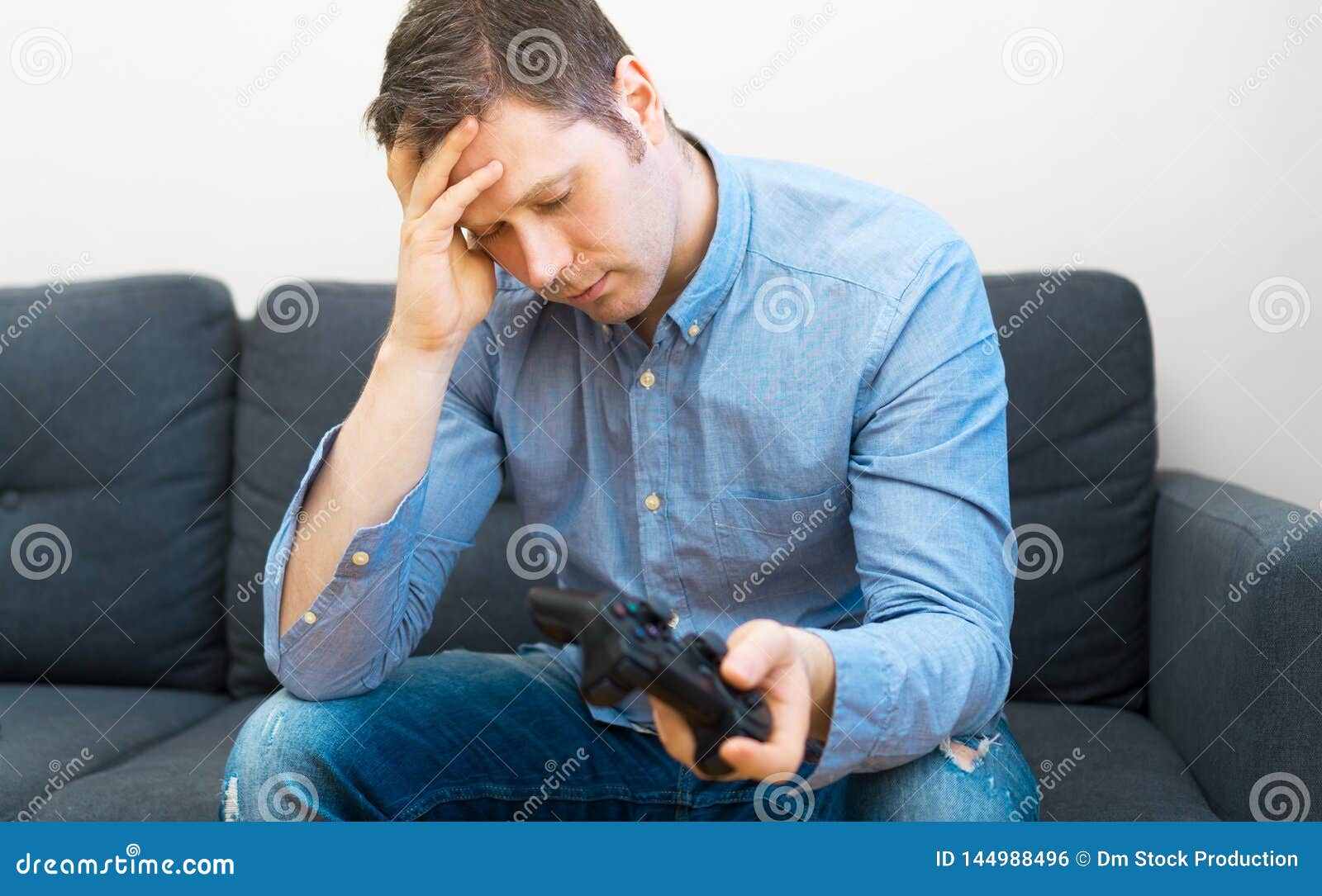 Sad man with gamepad stock photo. Image of joystick - 144988496