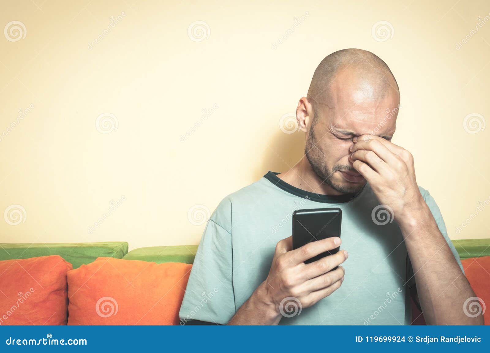 Sad Man Holding His Cell Phone In His Hands And Cry Because His