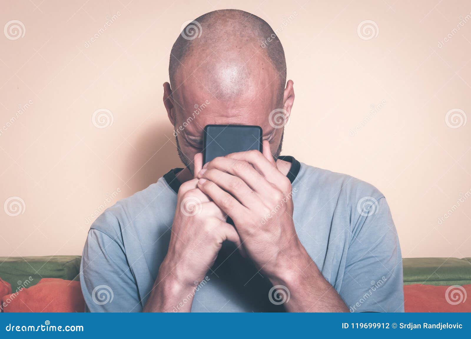 Sad Man Holding His Cell Phone In His Hands And Cry Because His