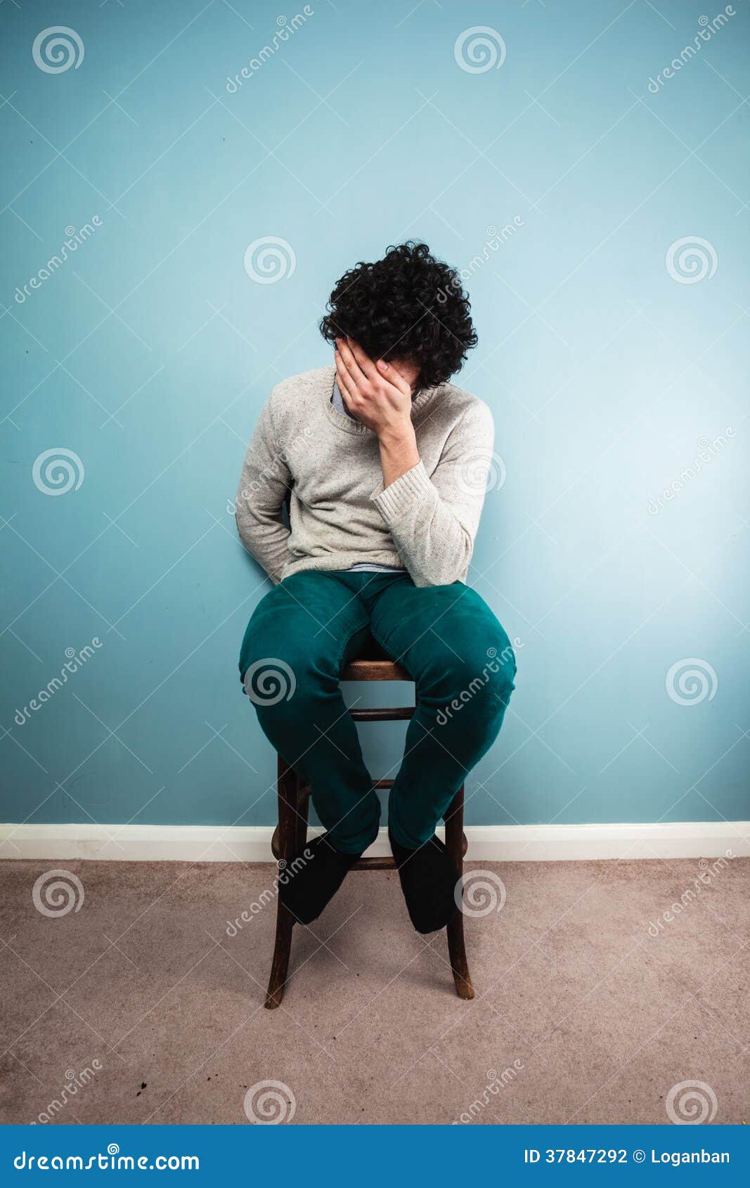 Sad man sitting on a chair stock photo. Image of depressed - 37847292