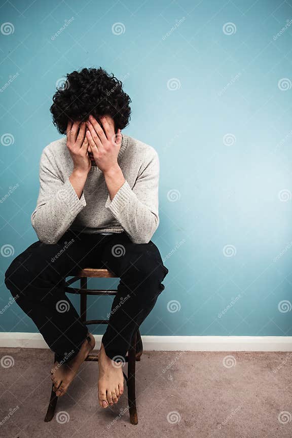 Sad man sitting on a chair stock image. Image of people - 37850127