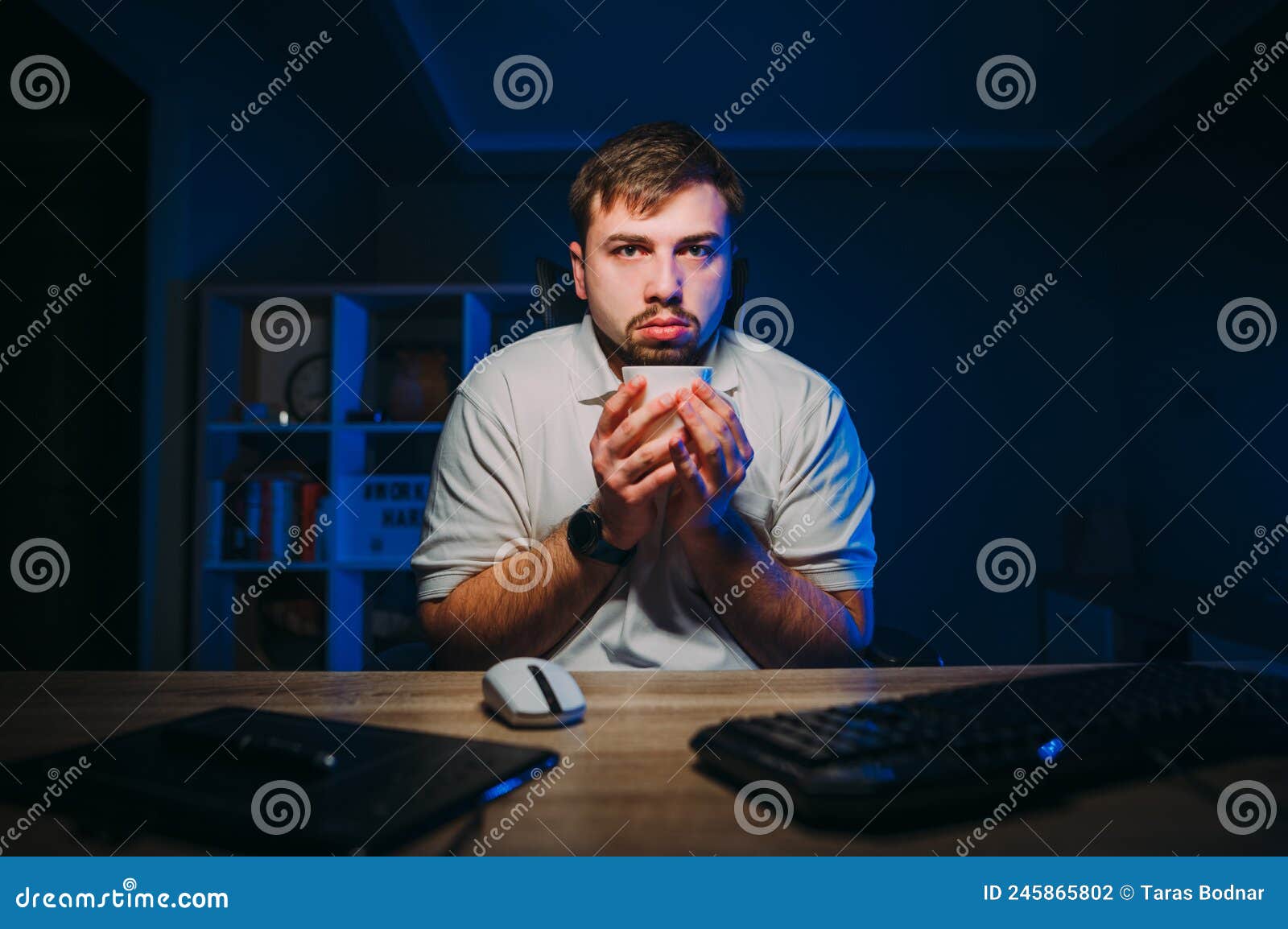 Sad Man Sitting at Home at Night at the Computer with a Cup of Hot Tea ...
