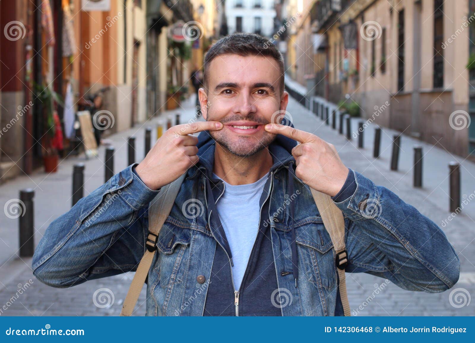 Sad man trying to smile stock photo. Image of attractive - 142306468