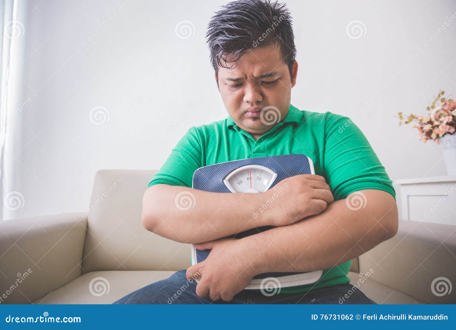 Sad Obese Man Holding a Weight Scale, Thinking about His Weight Stock ...