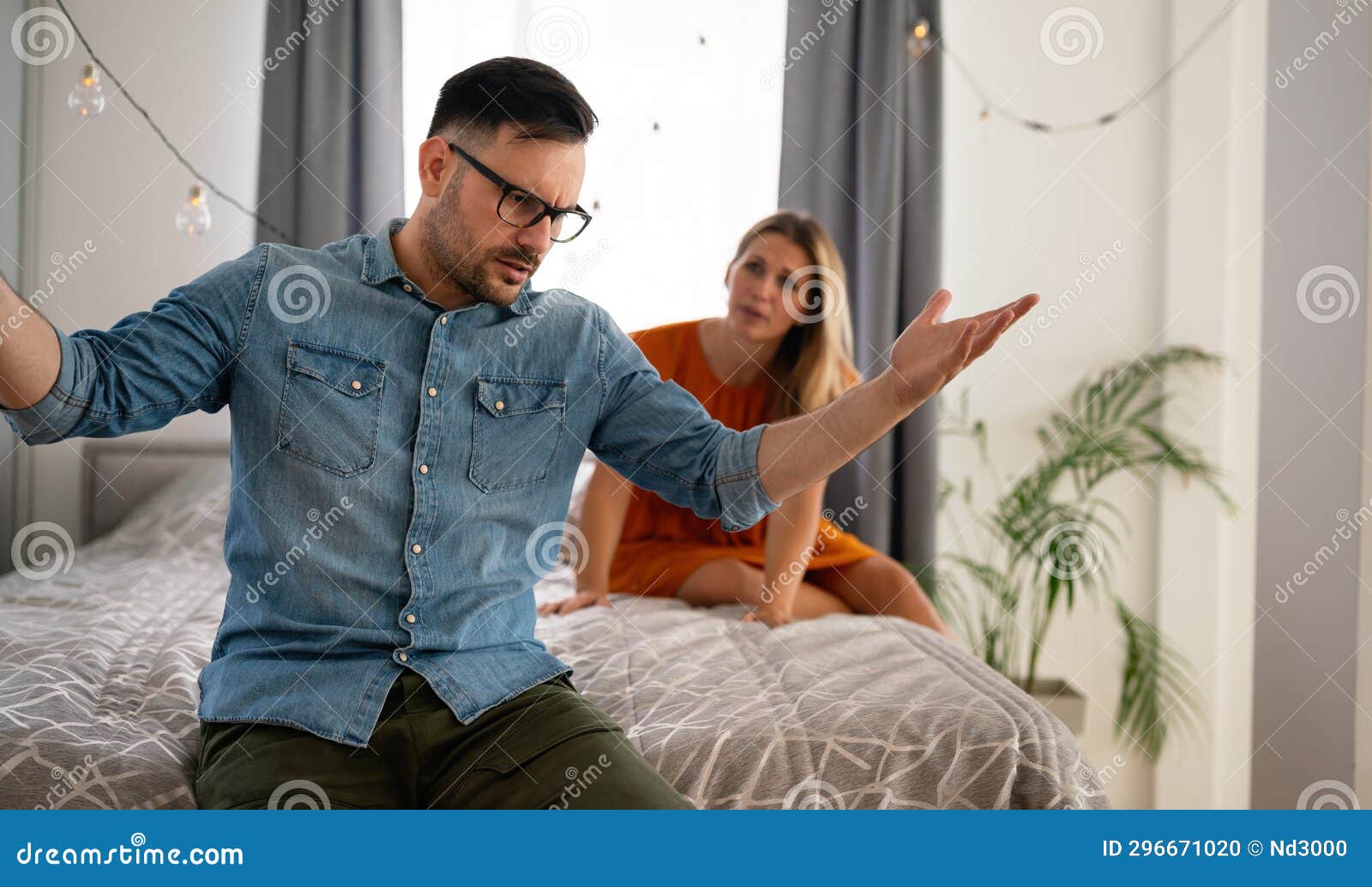 Sad Pensive Couple Thinking Of Relationships Problems Sitting On Sofa