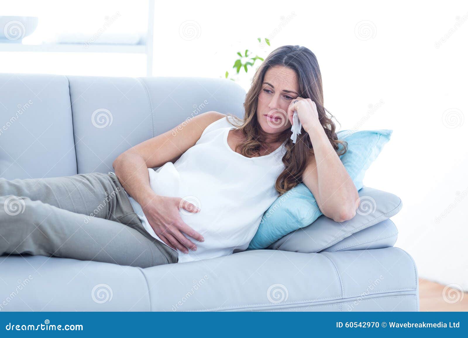 Sad Pregnant Woman Lying On Sofa Stock Photo | CartoonDealer.com #60542970