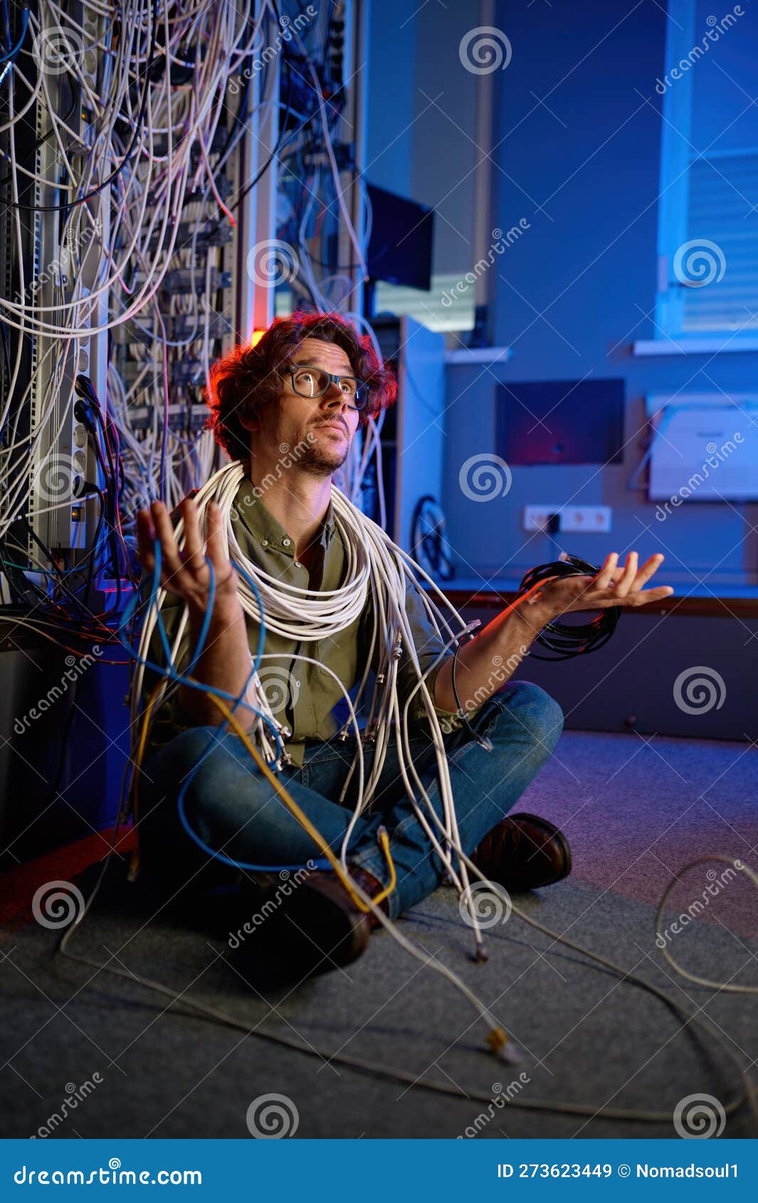 Sad, Puzzled Technician Holding Many Cables in Hand Trying To Solve ...