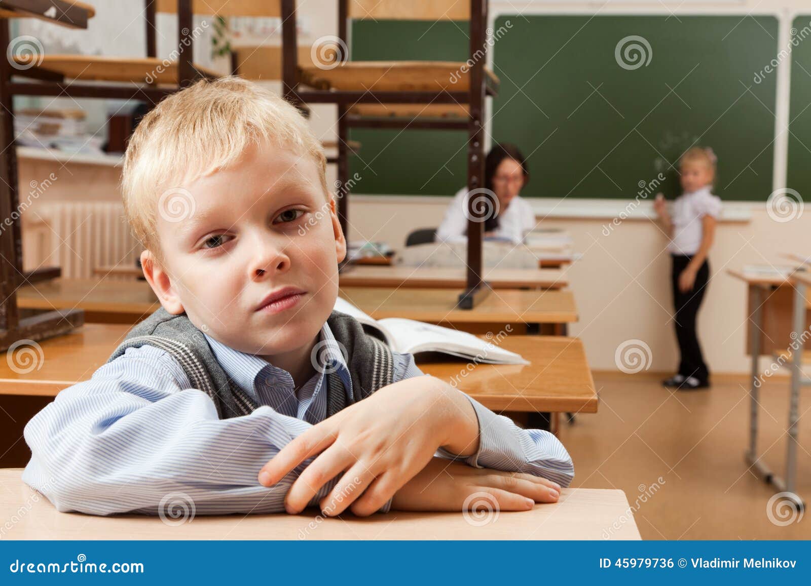 Sad schoolboy in classroom stock photo. Image of classroom - 45979736