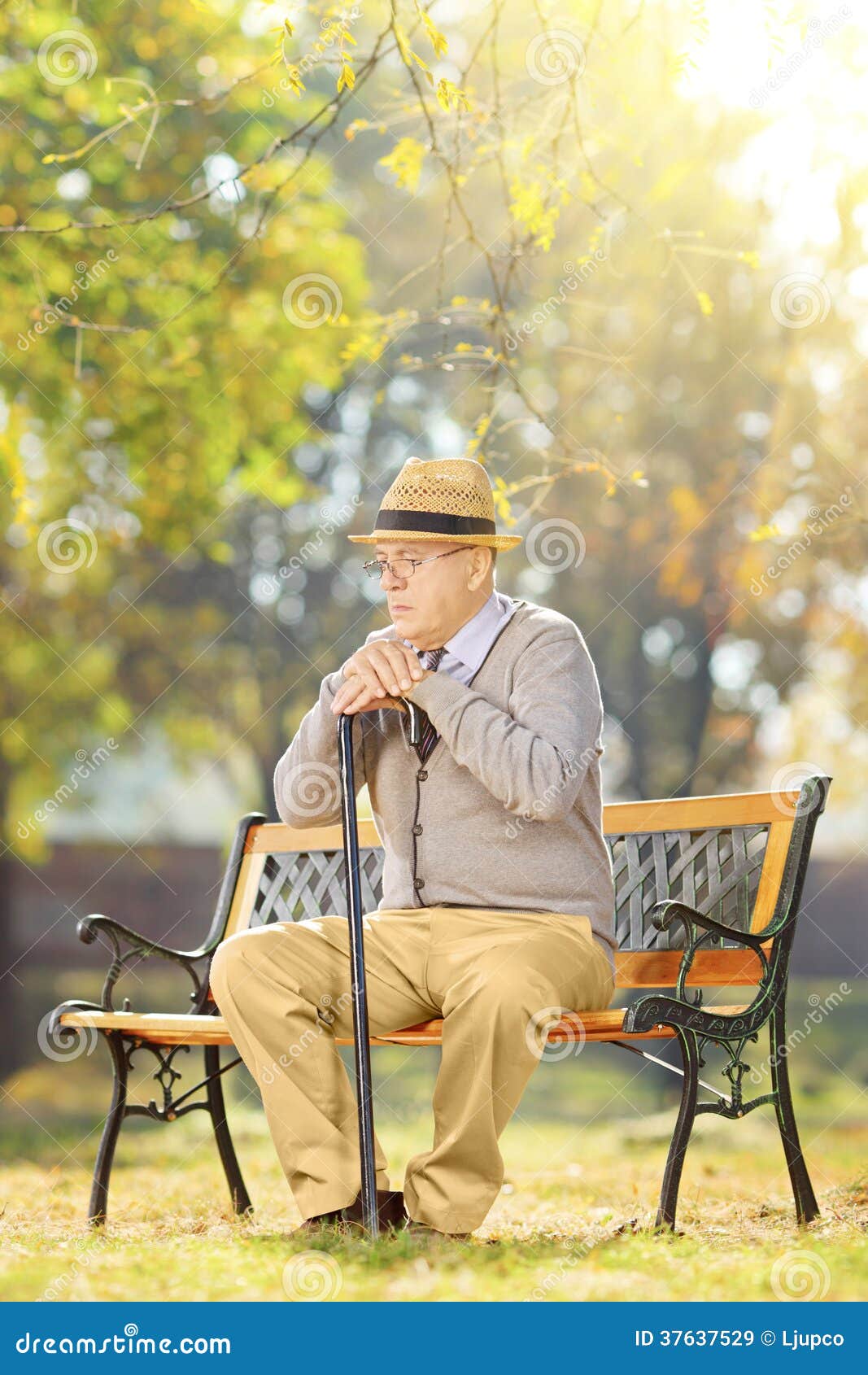 Sad Senior Man with a Cane Sitting on Bench in a Park Stock Image ...