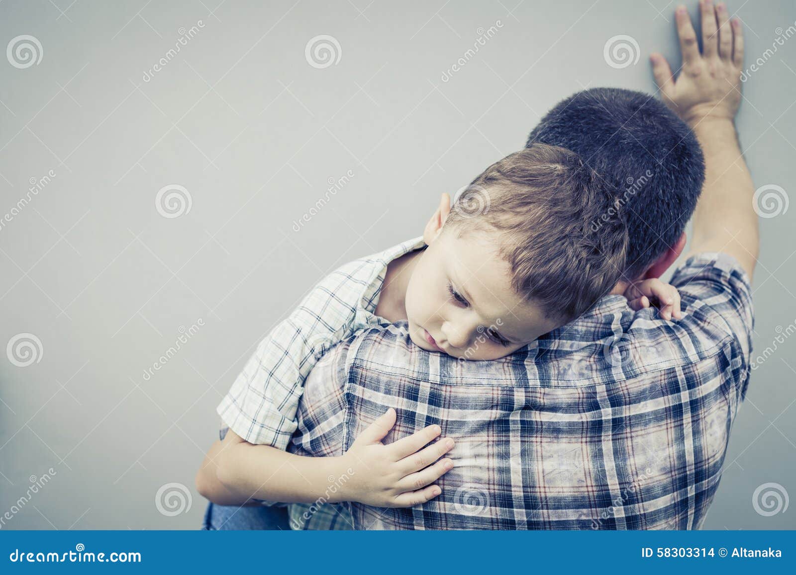 Sad son hugging his dad stock photo. Image of pain, face - 58303314