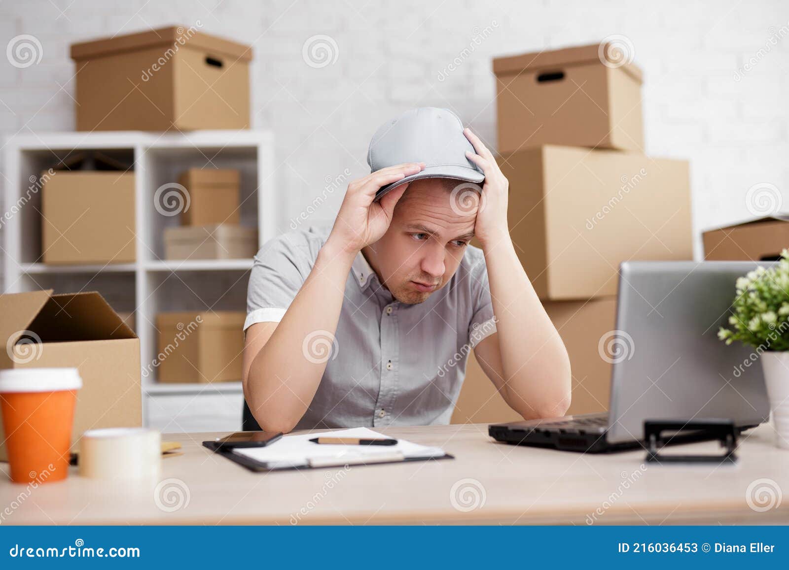 Sad or Tired Postman in Post Office with Boxes Behind of Him Stock ...