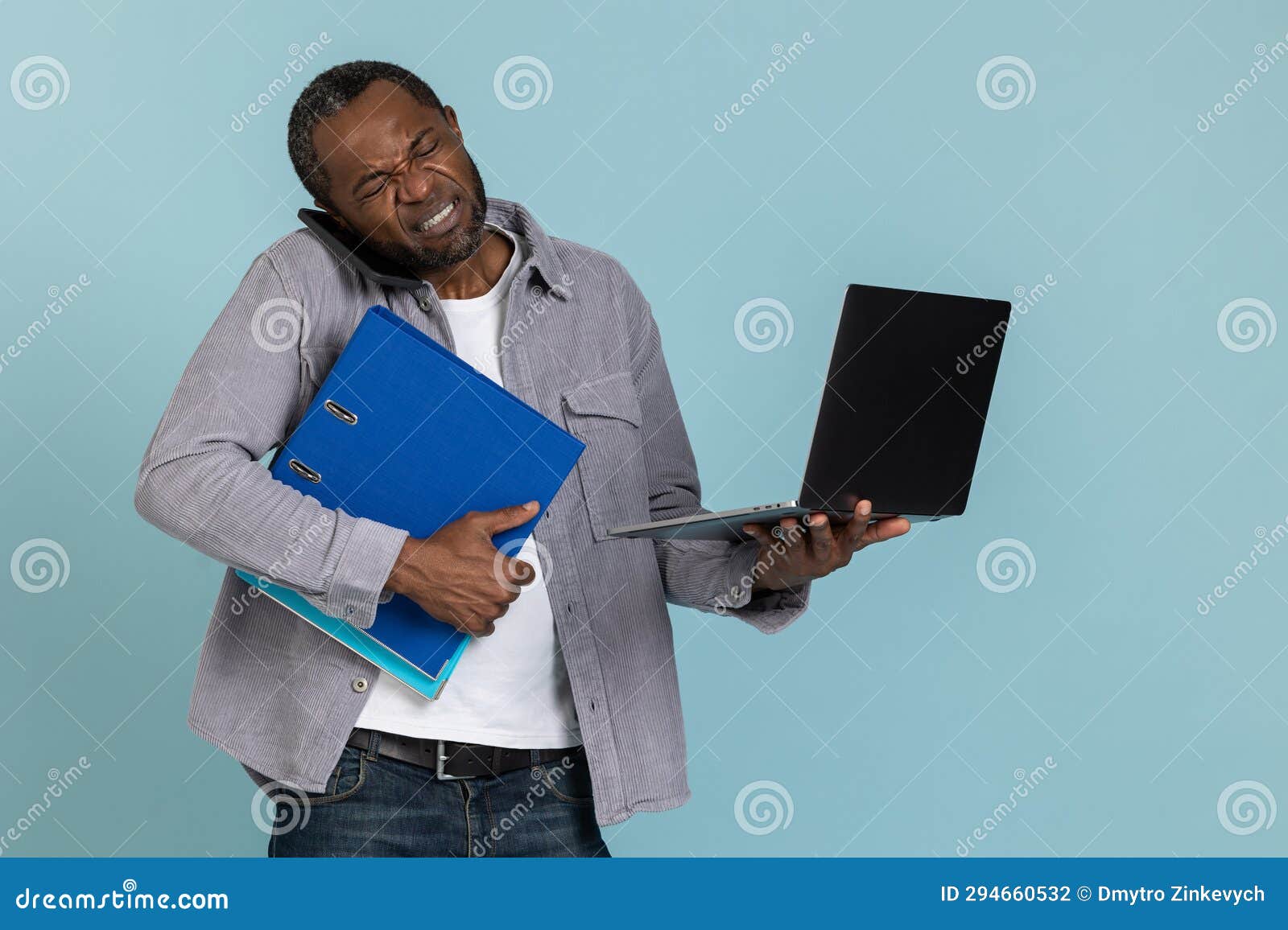 Sad Unhappy Man Talking on Smartphone and Using Laptop while Working in ...