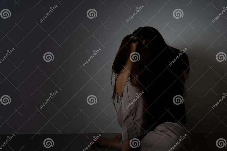 Sad Woman Hug Her Knee And Cry Sitting Alone In A Dark Room Depression