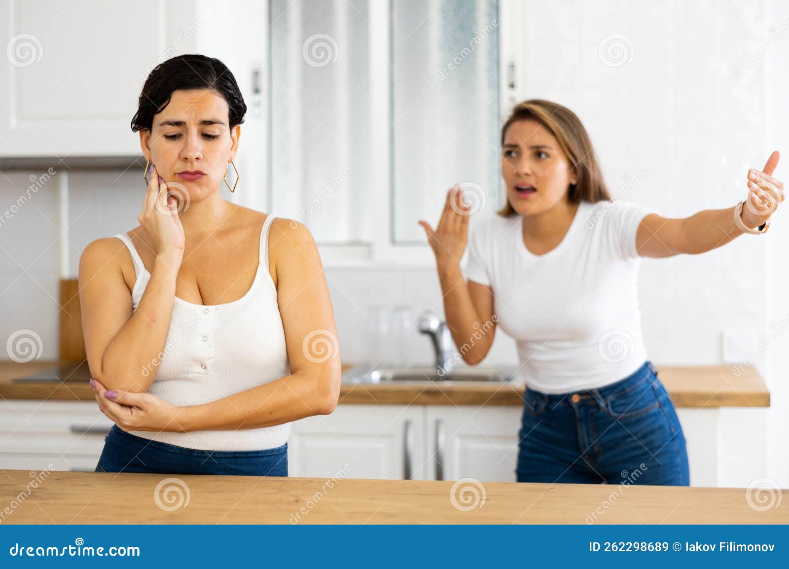 Woman Ignoring Her Girlfriend Standing In Background And Arguing With