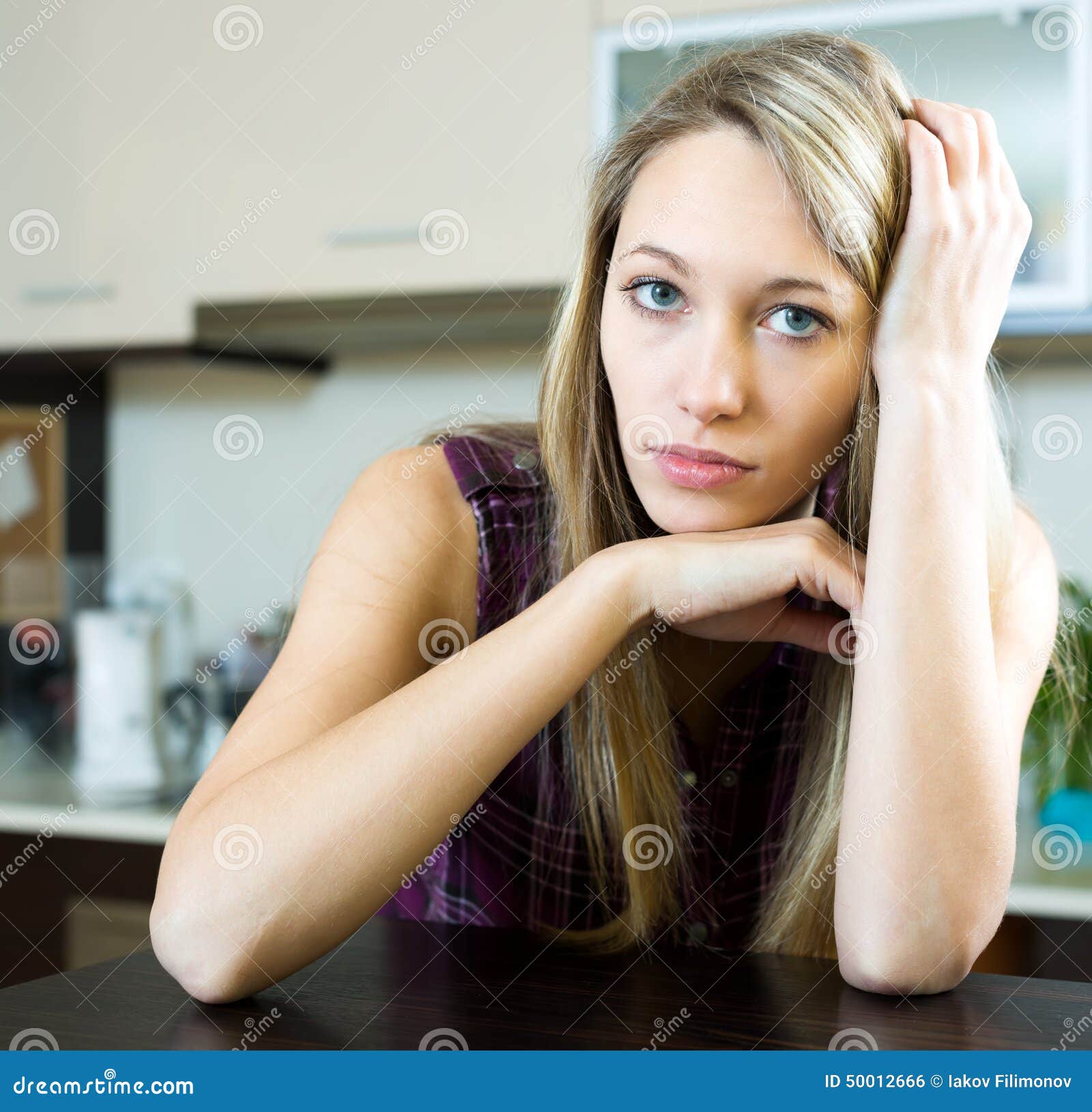 Sad woman at kitchen table stock photo. Image of depressed - 50012666