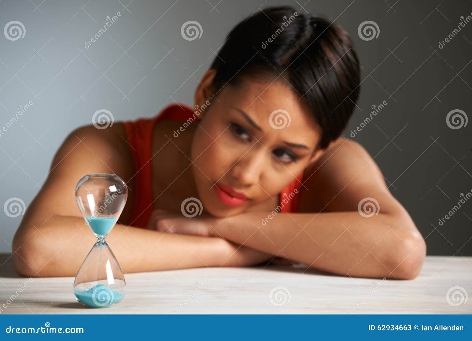 Sad Woman Looking at Hourglass Stock Image - Image of process, shot ...