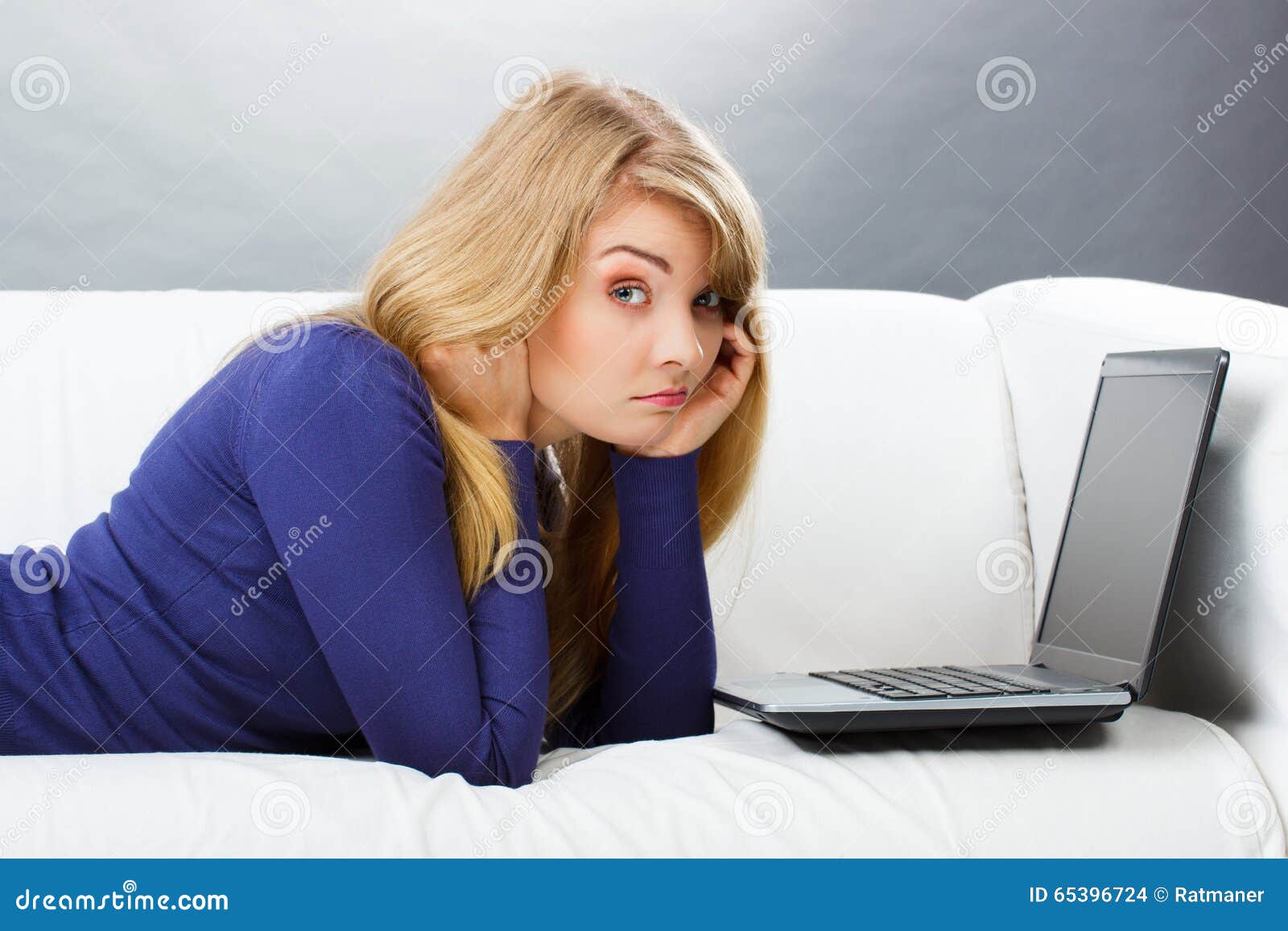 Sad Woman Lying on Sofa and Using Laptop, Modern Technology Stock Photo ...
