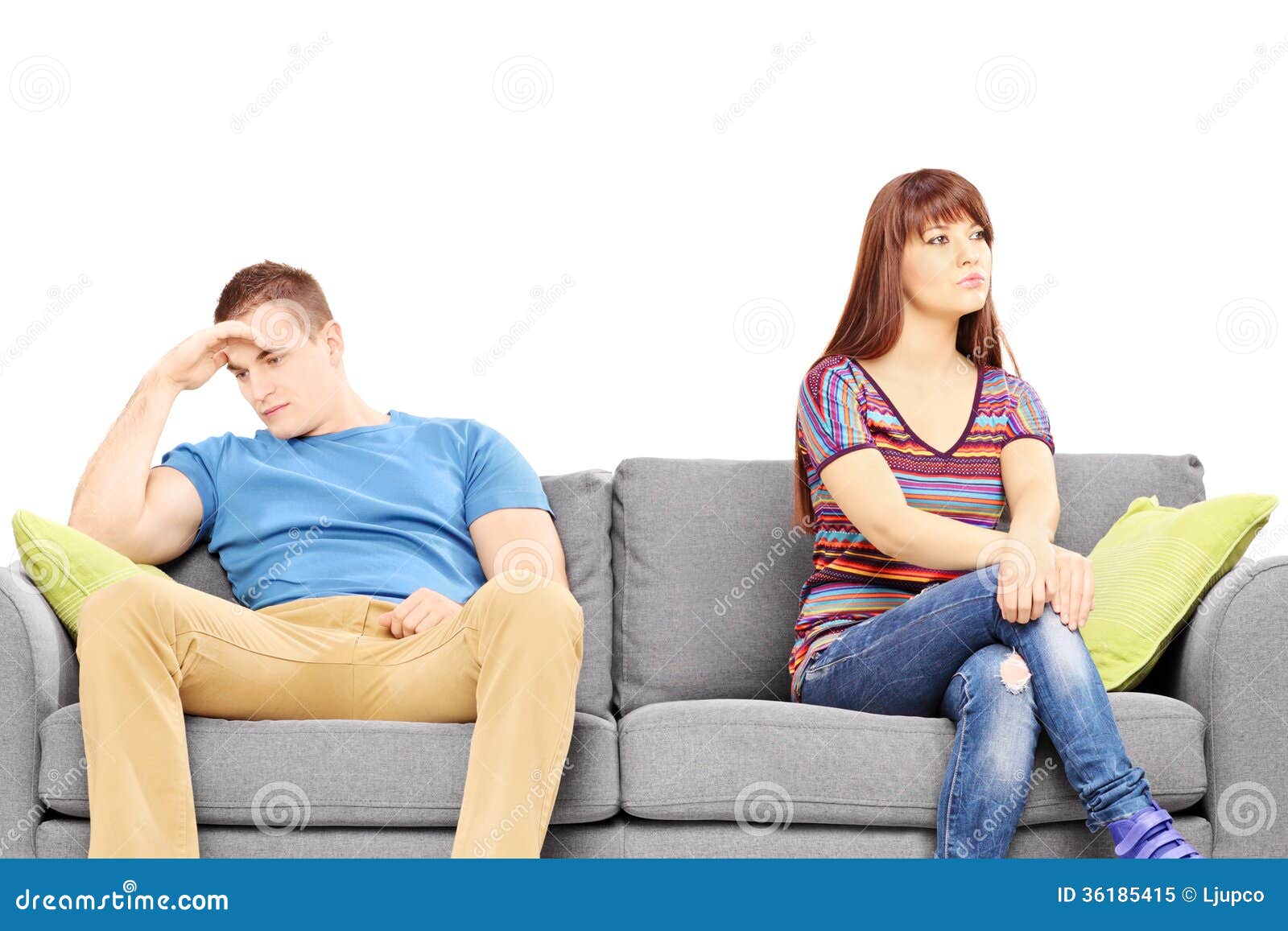 Sad Young Couple Sitting On A Sofa After An Argument Stock Image