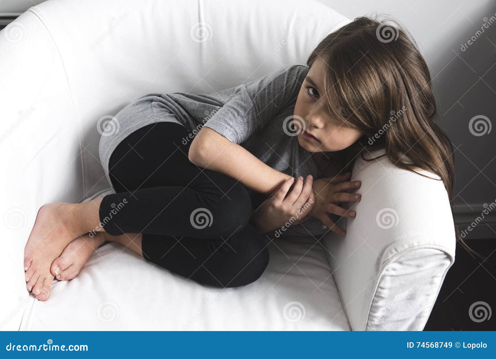 Sad young girl lay on sofa stock image. Image of caucasian - 74568749