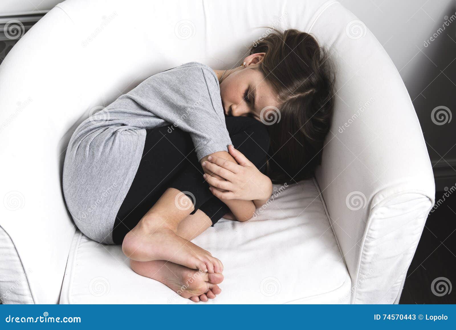 Sad young girl lay on sofa stock image. Image of beautiful - 74570443