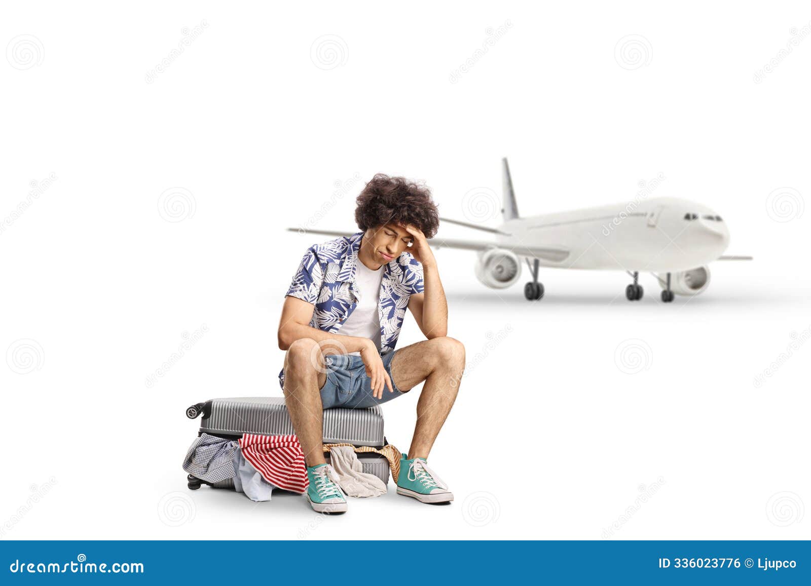 Sad Young Man with Overpacked Suitcase Waiting for a Flight Stock Photo ...