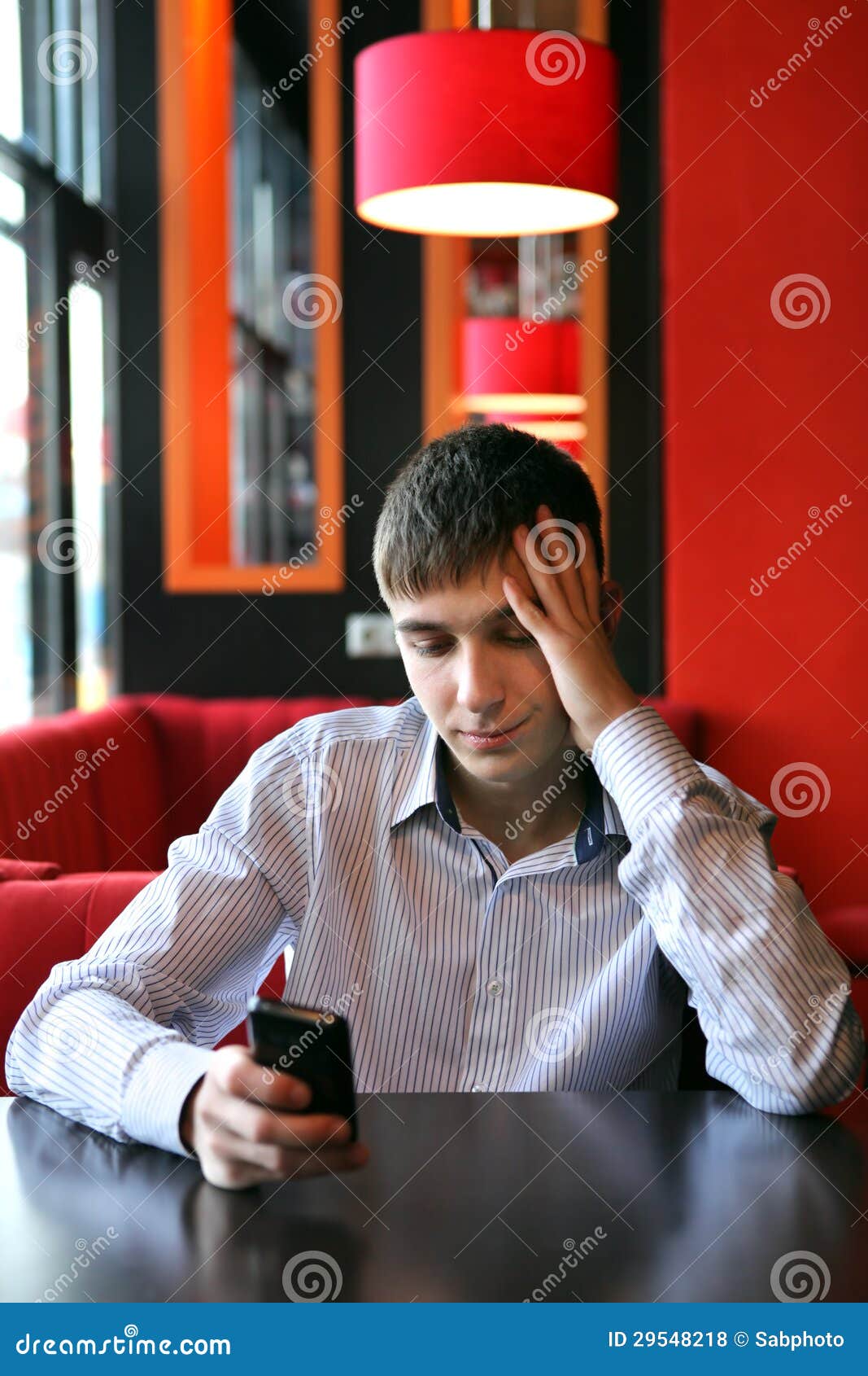 Sad Young Man with Phone stock photo. Image of pensive - 29548218