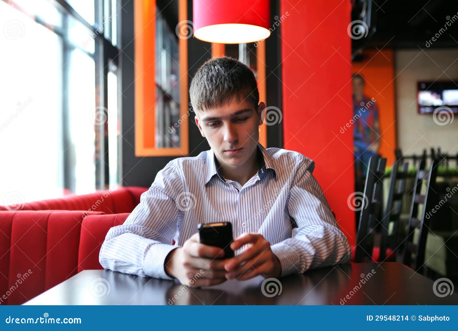 Sad Young Man in Restaurant Stock Photo - Image of gadget, shirt: 29548214