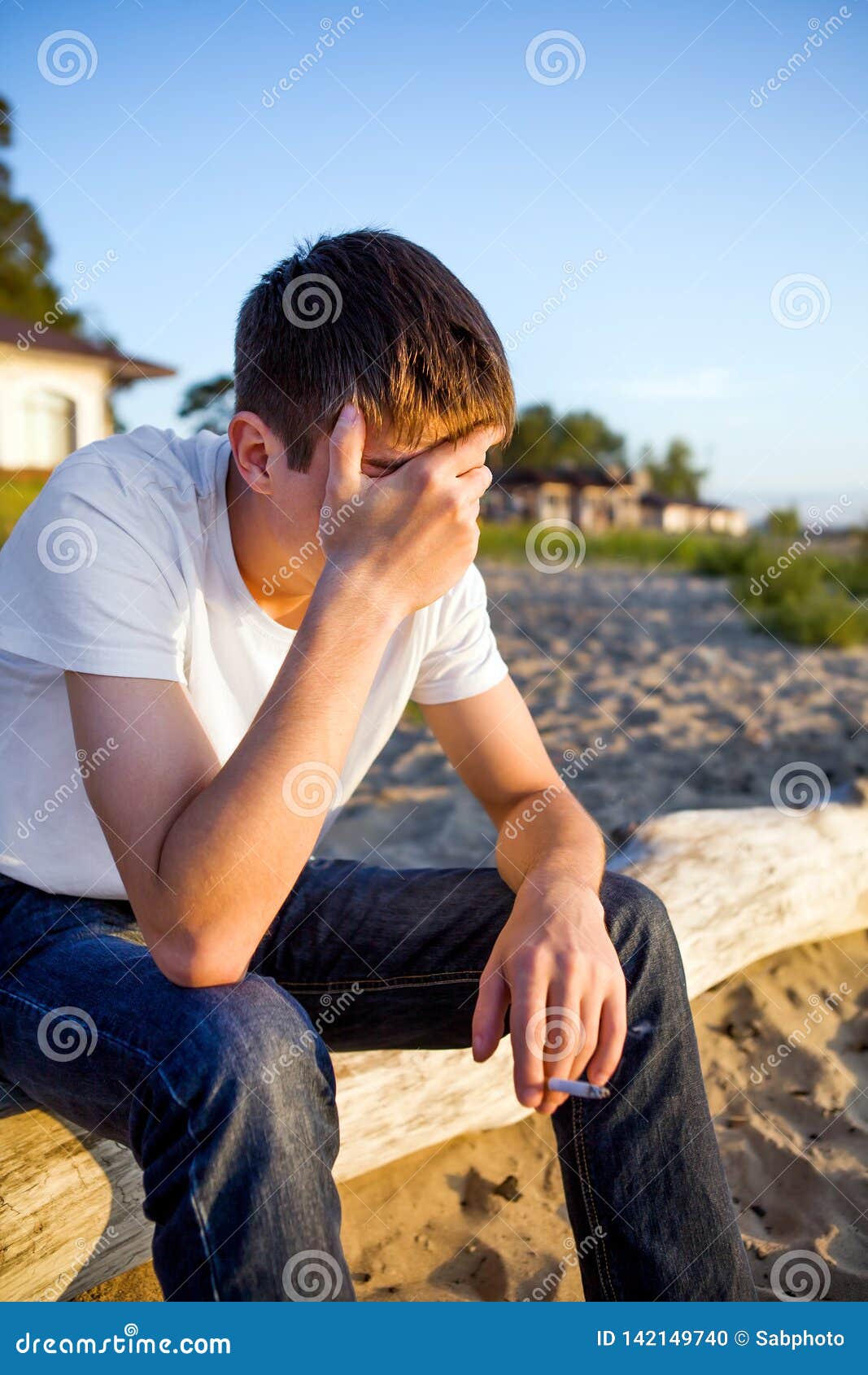 Sad Young Man stock photo. Image of casual, grief, outside - 142149740