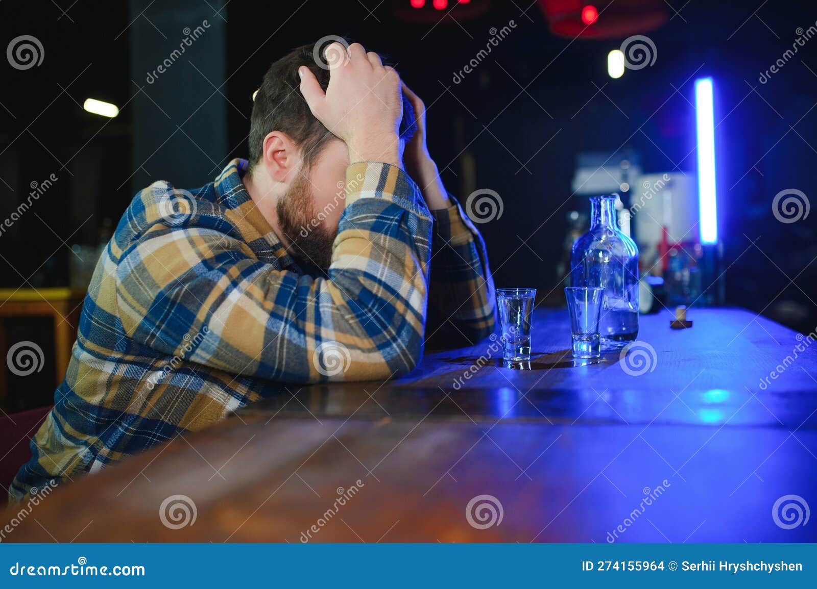 Sad Young Man Sitting at Bar Counter in Pub. Upset Man Drinks Alcohol ... Sad Young Man Sitting at Bar Counter in Pub. Upset Man Drinks Alcohol ...