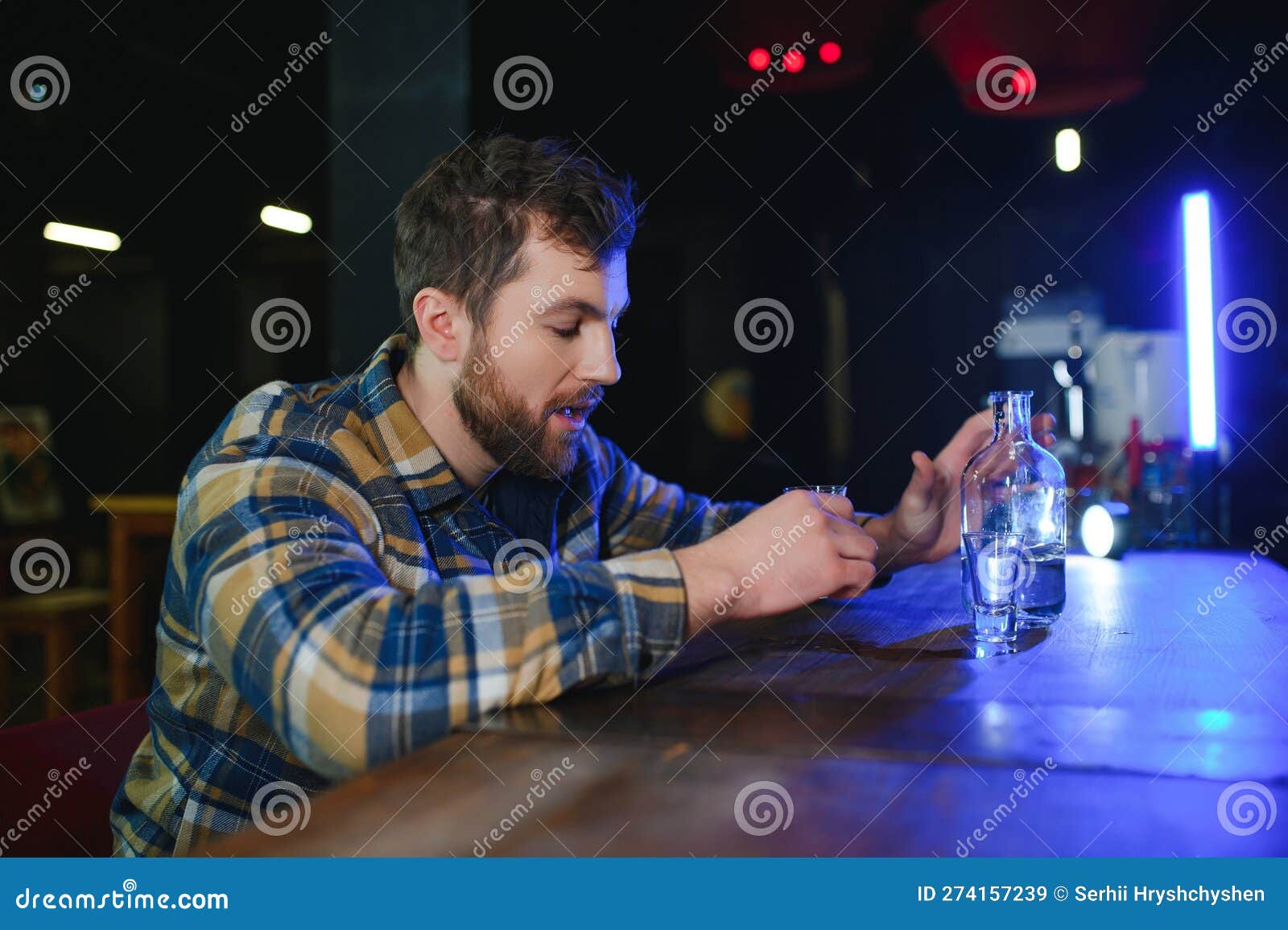 Sad Young Man Sitting at Bar Counter in Pub. Upset Man Drinks Alcohol ... Sad Young Man Sitting at Bar Counter in Pub. Upset Man Drinks Alcohol ...