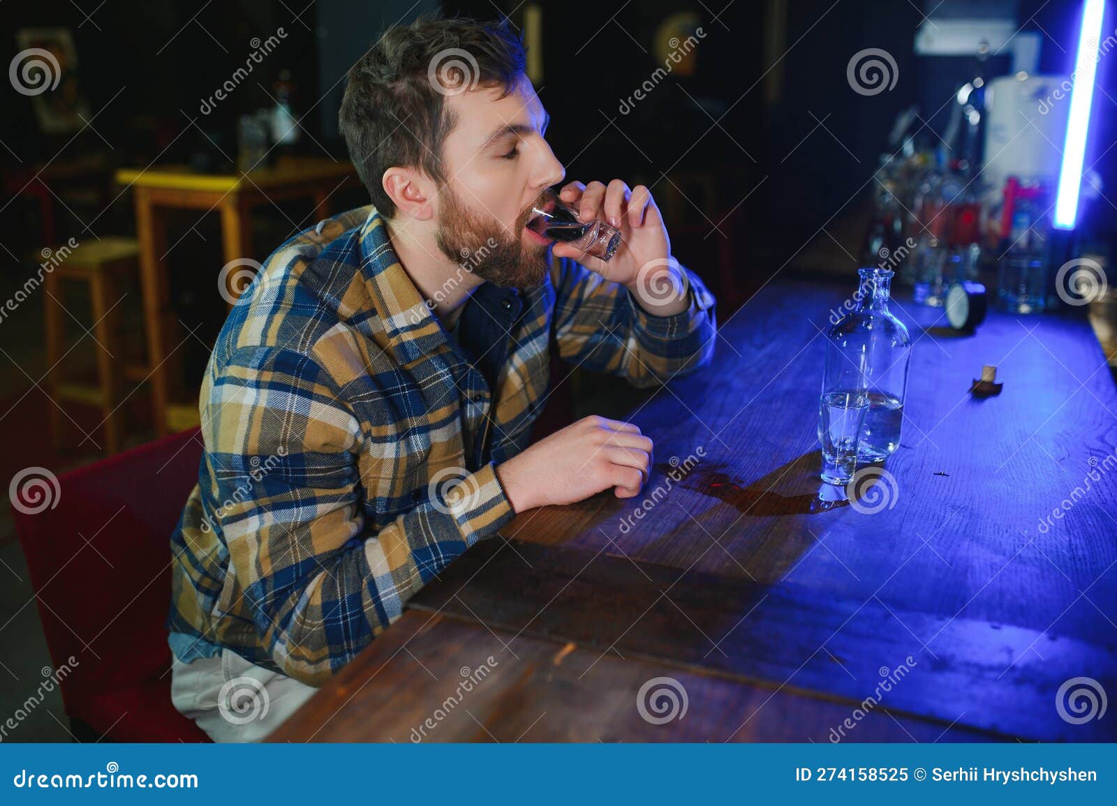 Sad Young Man Sitting at Bar Counter in Pub. Upset Man Drinks Alcohol ... Sad Young Man Sitting at Bar Counter in Pub. Upset Man Drinks Alcohol ...