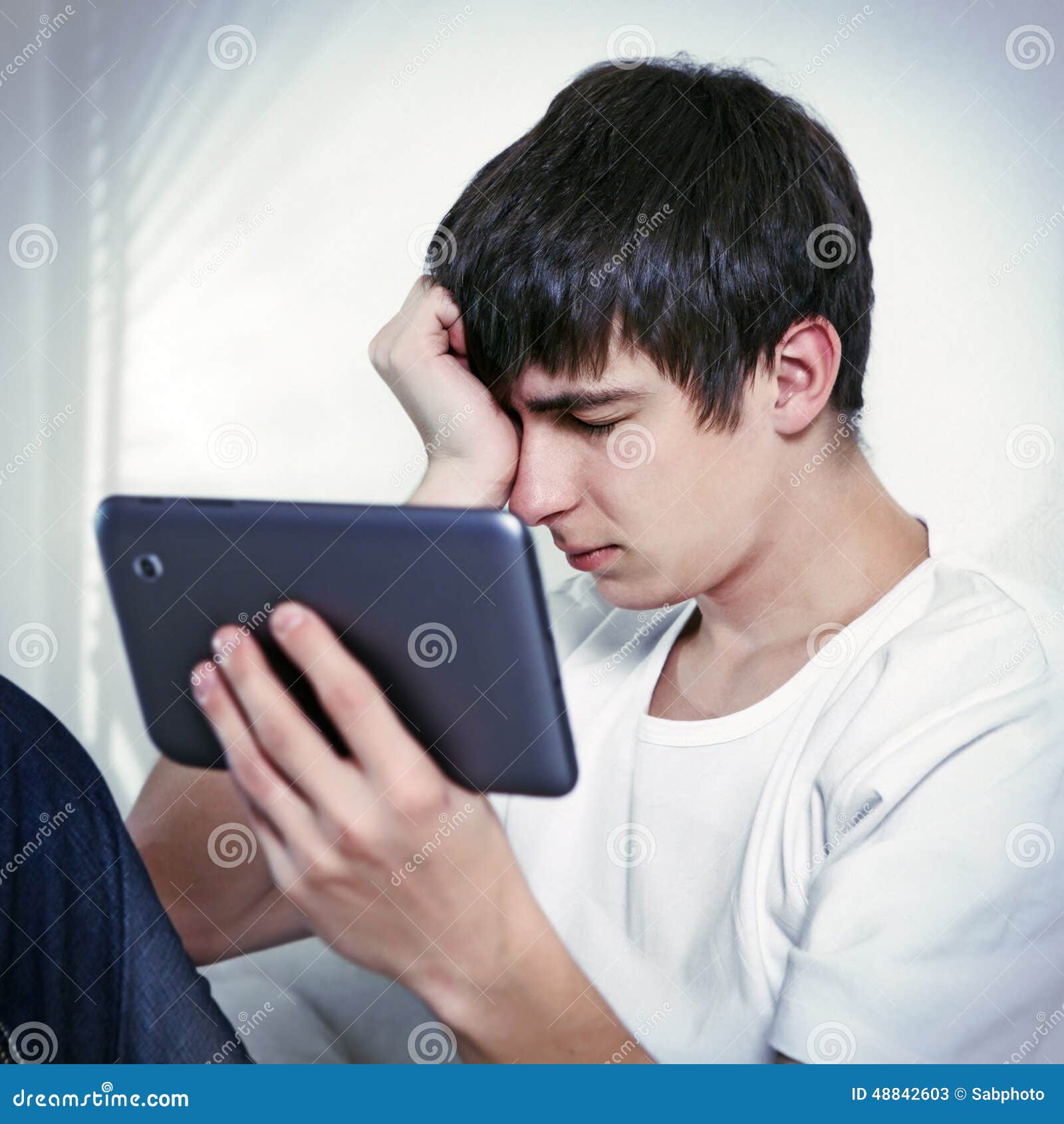 Sad Young Man with Tablet stock image. Image of closeup - 48842603