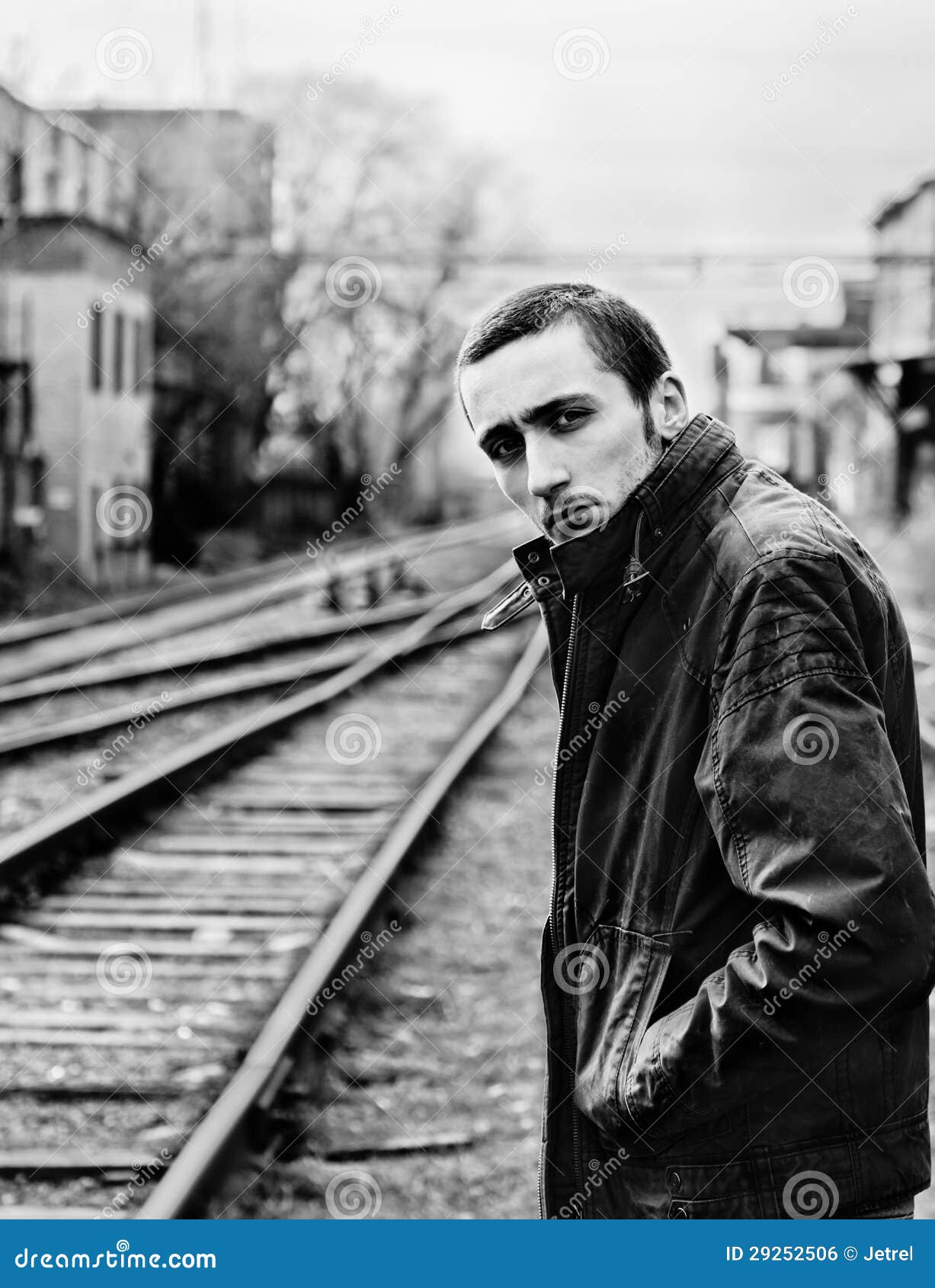Sad Young Man Waiting for the Train among Industrial Ruins Stock Photo ...