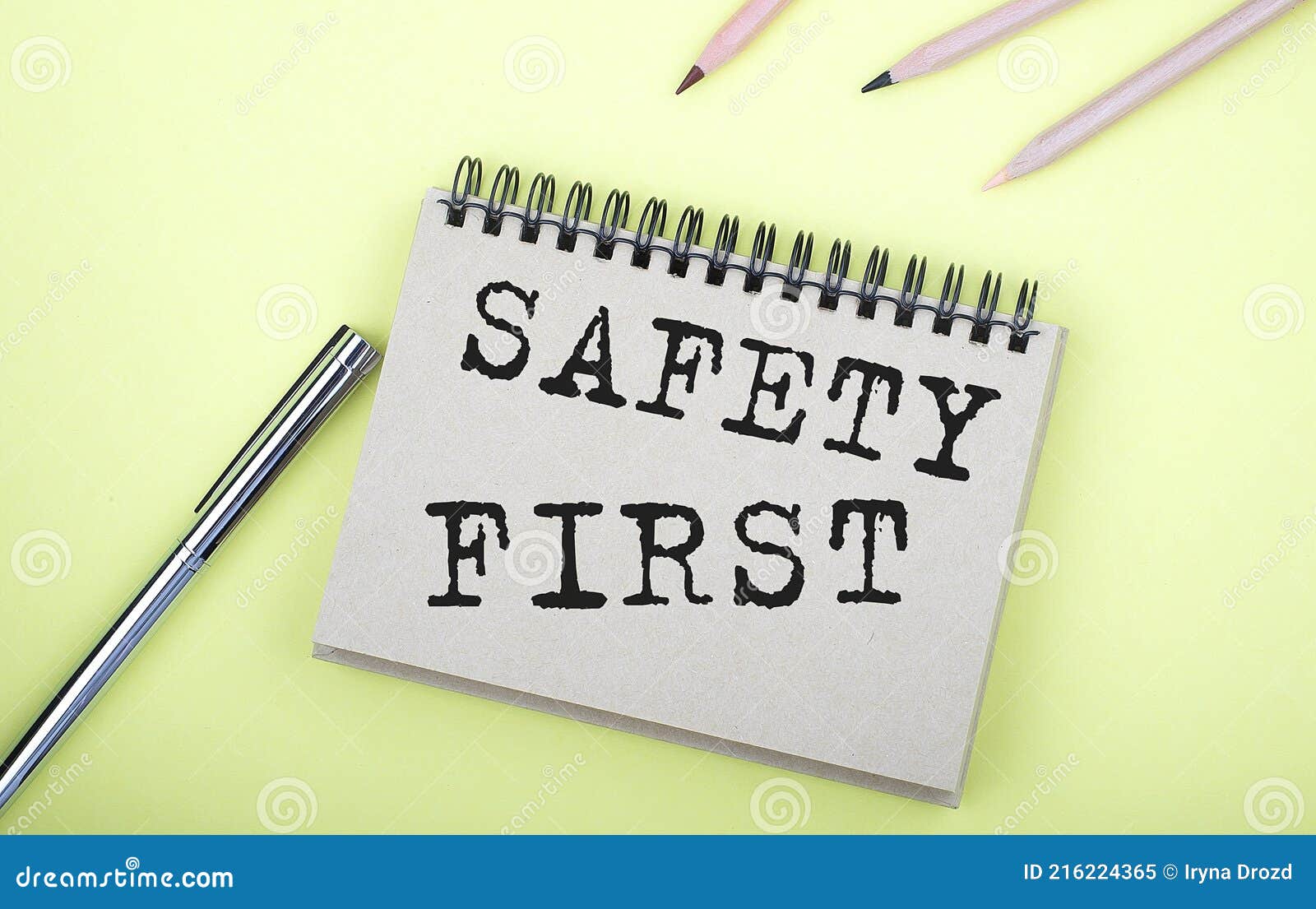 Safety First Text on the Notebook with Pen on the Yellow Background ...