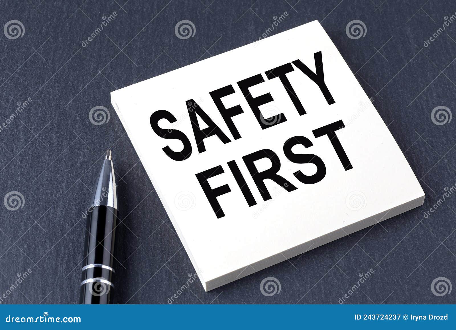 SAFETY FIRST Text on the Sticker with Pen on the Black Background Stock ...