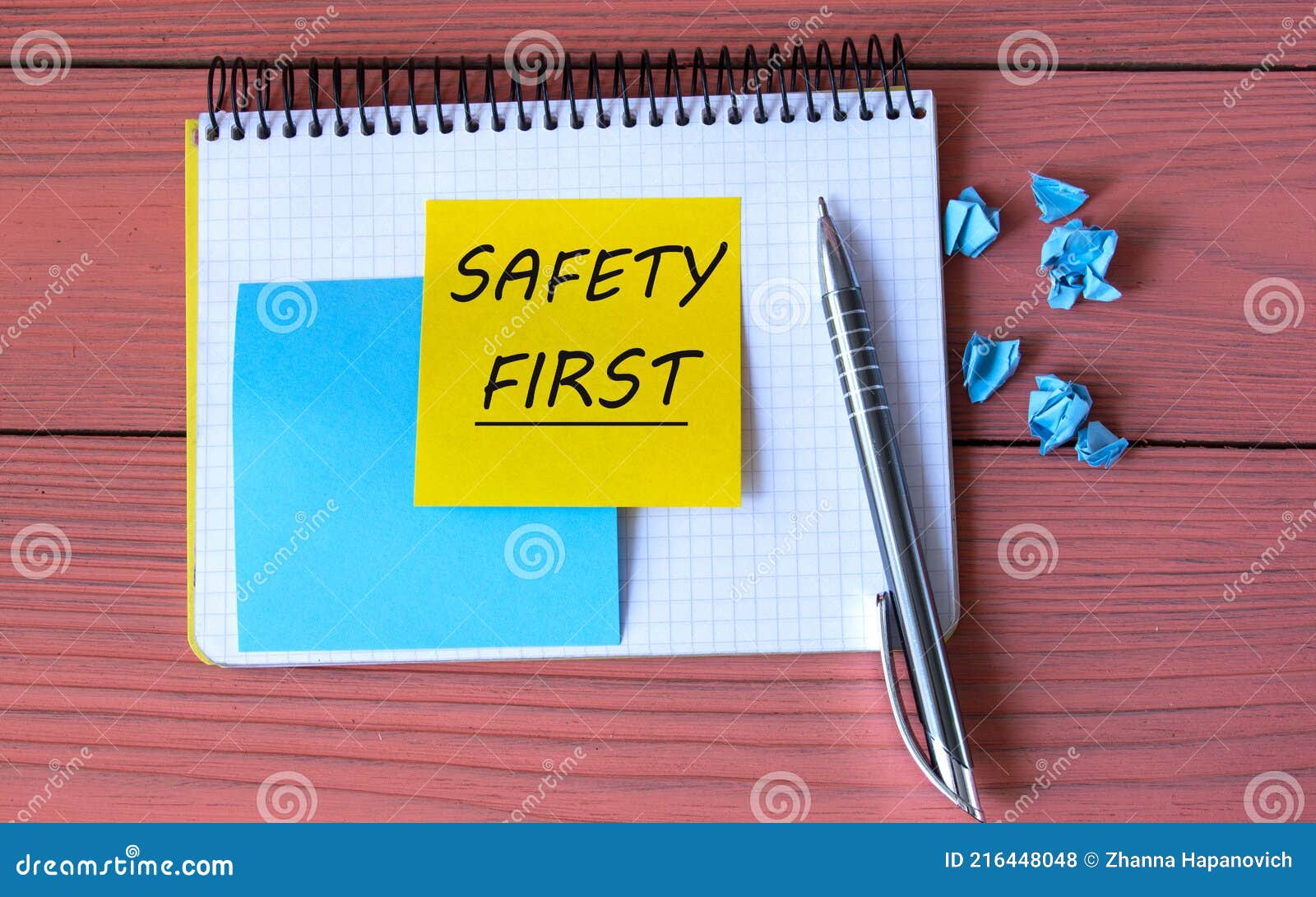 SAFETY FIRST - Words on a Note Sheet on a Pink Background with a Pen ...
