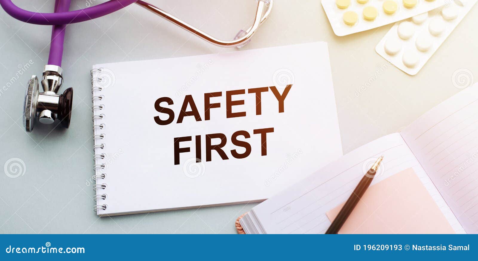 Safety First Written on Notebook on Table with Stethoscope and Tablets ...