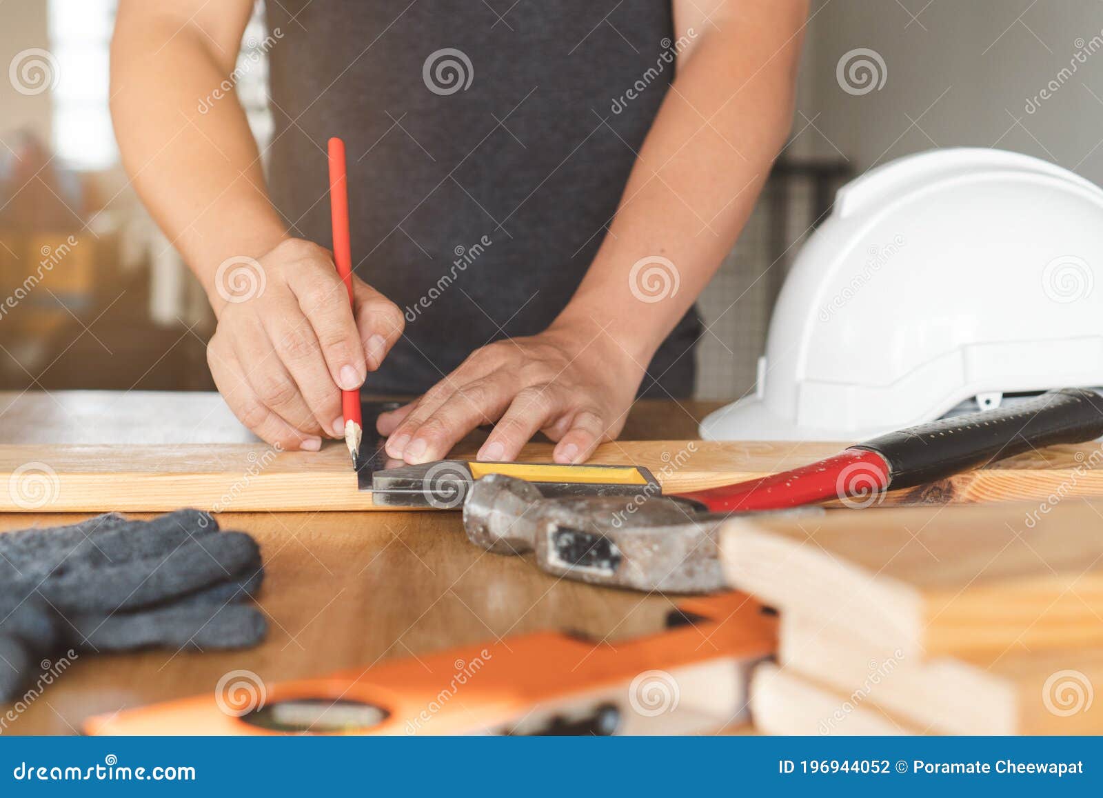 Safety Hard Hat on the Table and Worker As Background Stock Photo ...