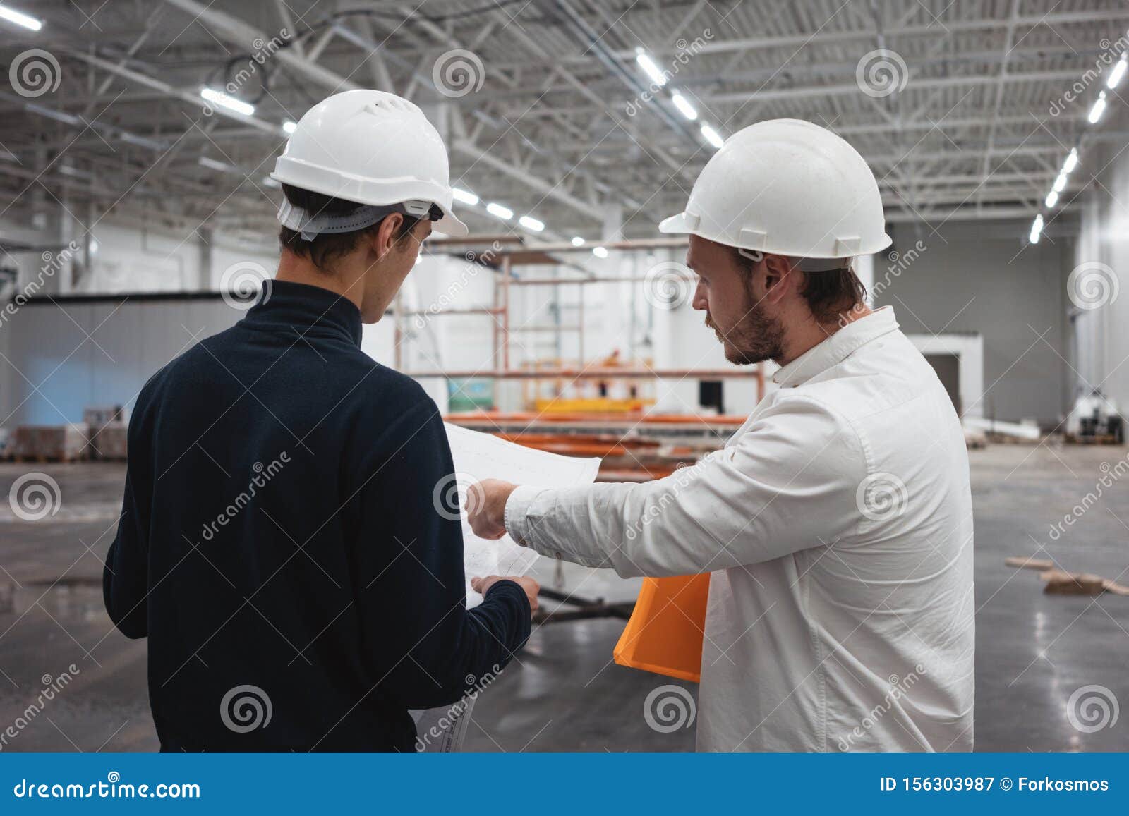 Safety Inspector and Build Worker Inside Building Under Construction ...