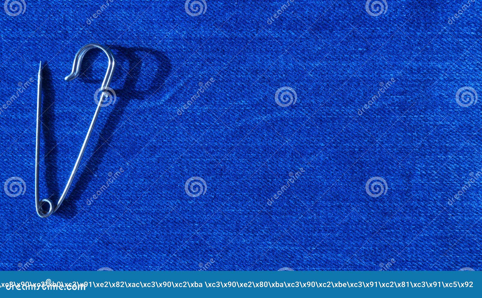 Safety Pin on a Blue Jeans Background Stock Image - Image of textile ...