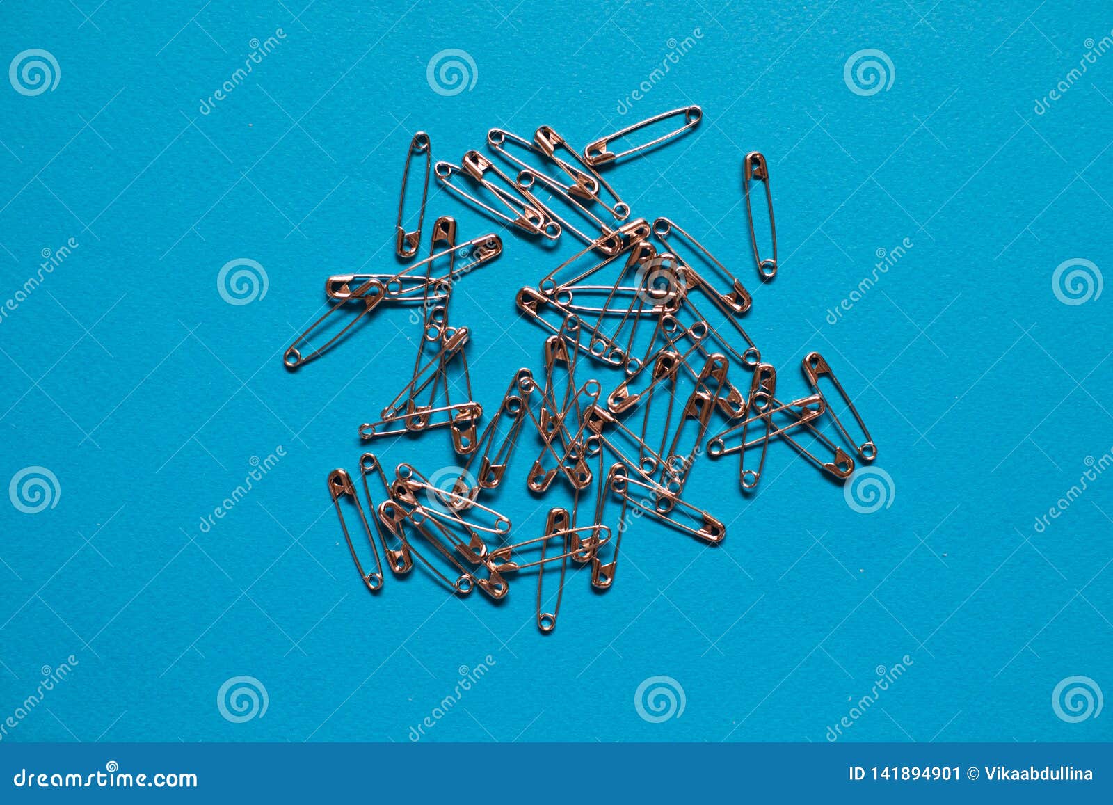 Safety Pins on Blue Background Stock Image - Image of pattern ...