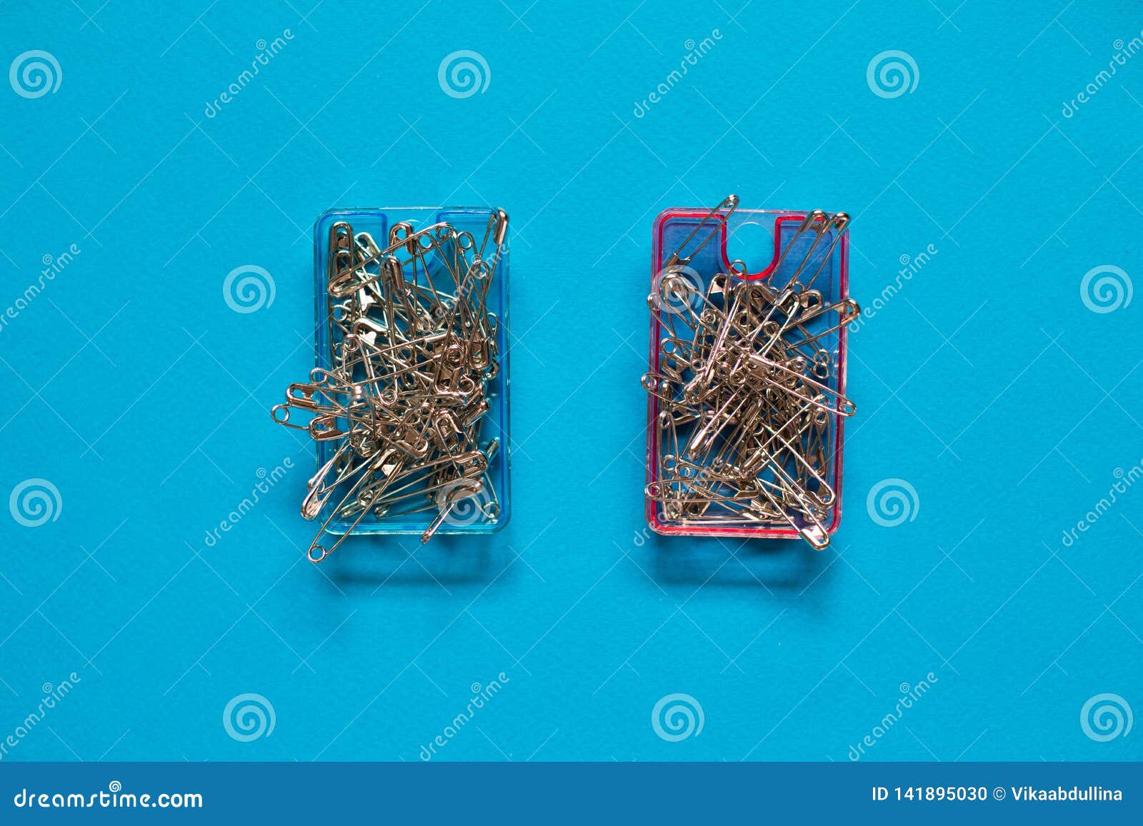 Safety Pins in Blue and Pink Plastic Boxes on Blue Background Stock ...