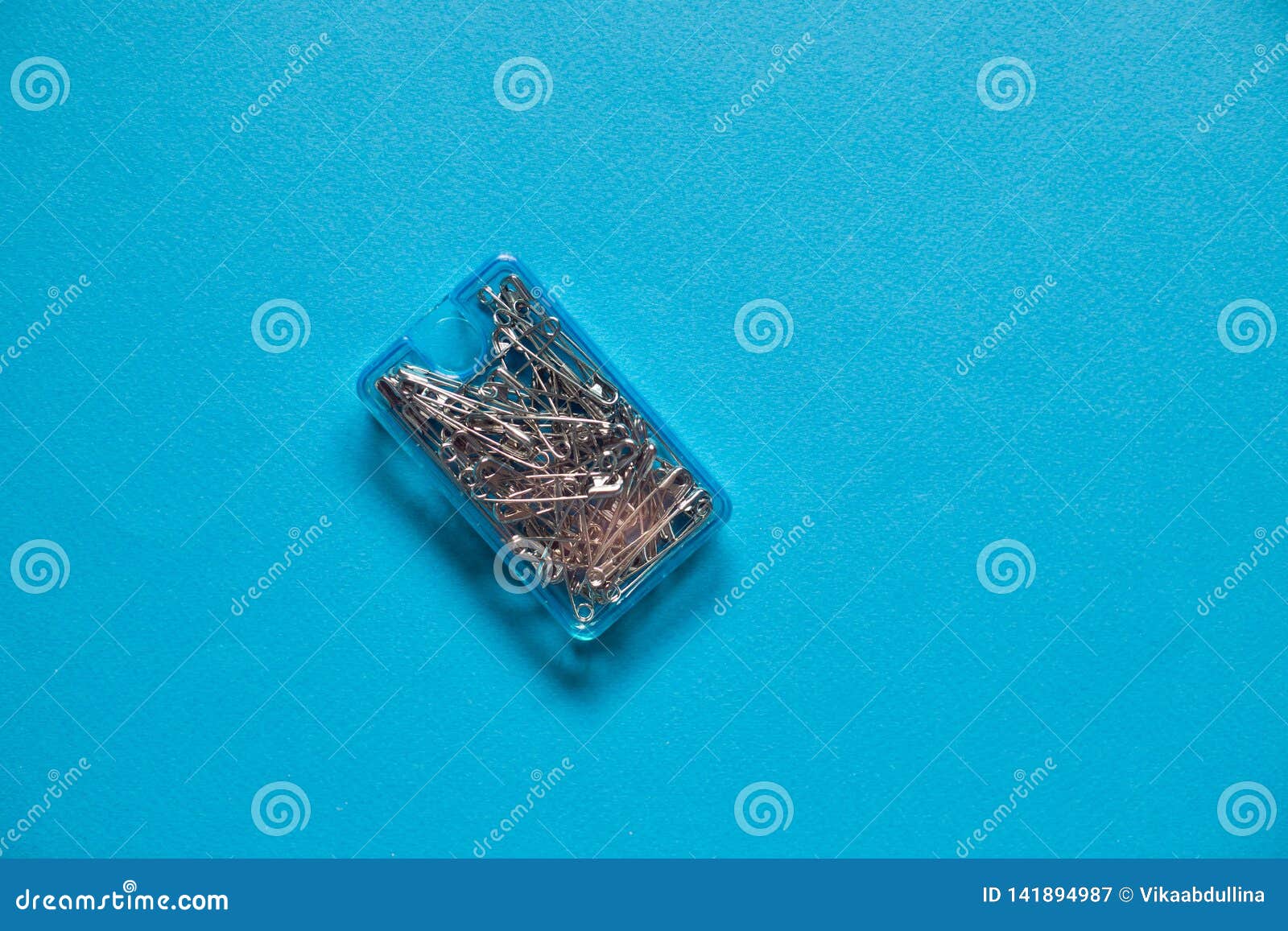 Safety Pins in Blue Plastic Box on Blue Background Stock Image - Image ...